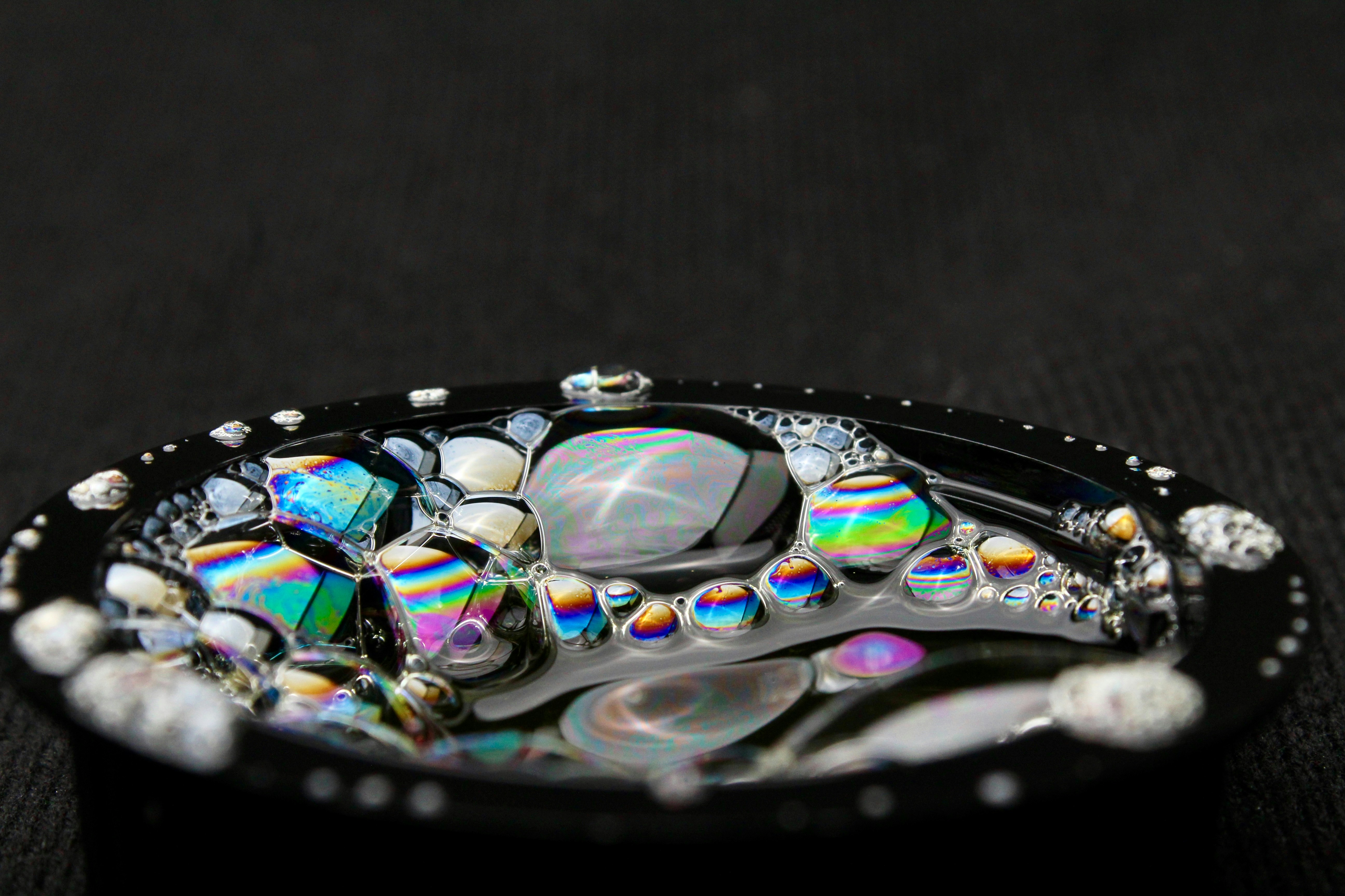 Iridescent Bubbles on a Dark Macro Dish
