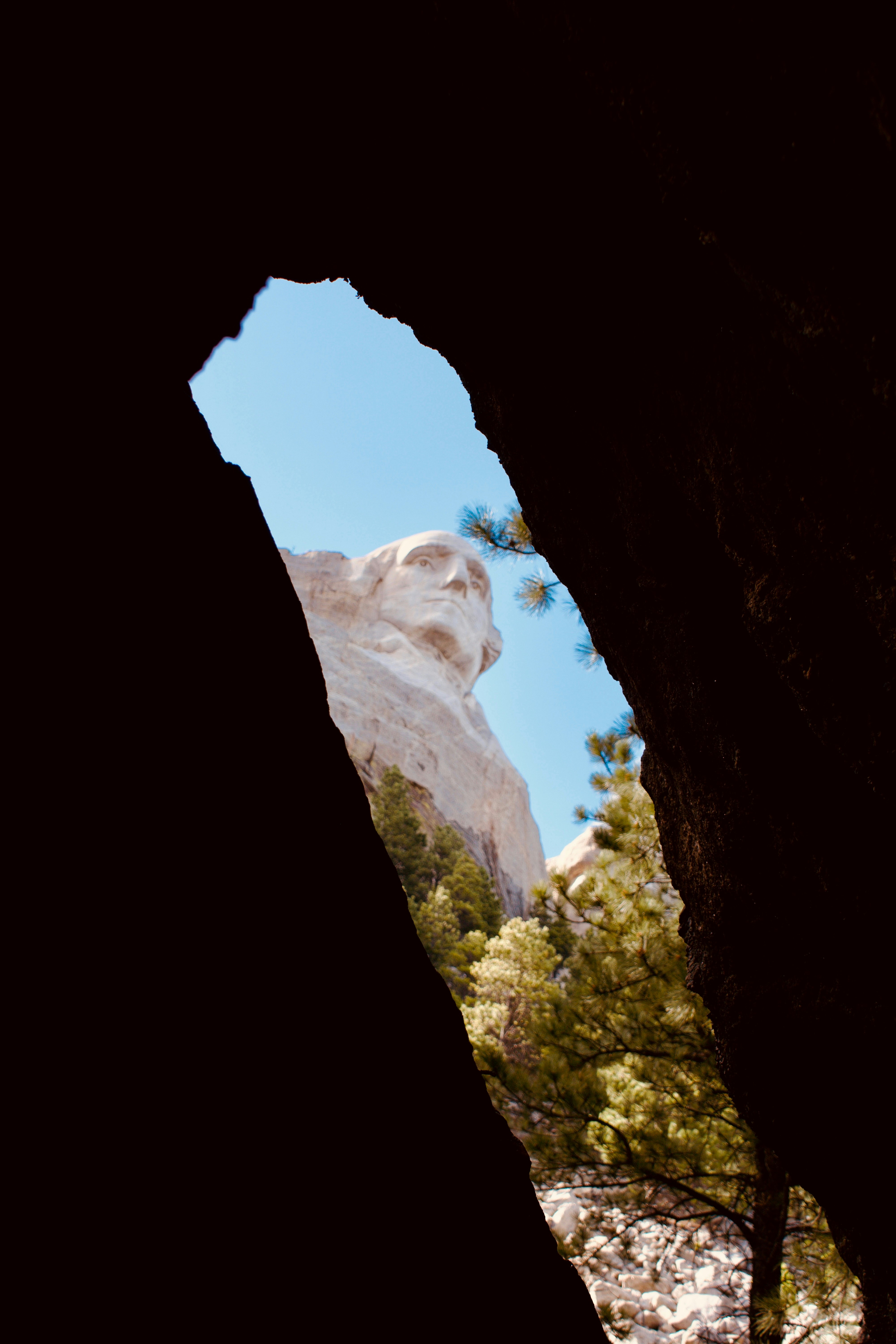 Hidden Carved Face: Light Awakens a Canyon Through a Narrow Window
