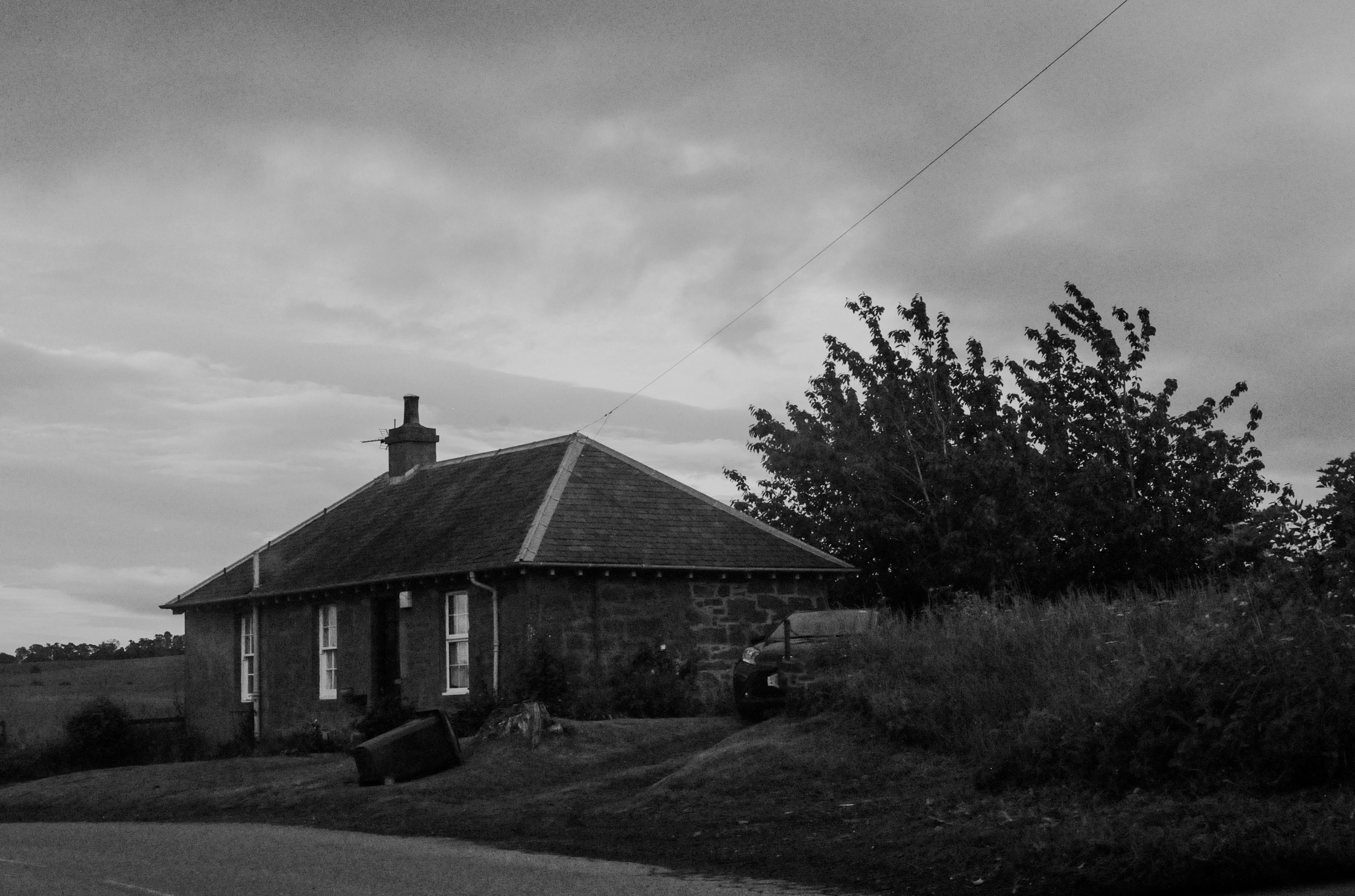 Deserted Brick Cottage by the Open Road at Dusk