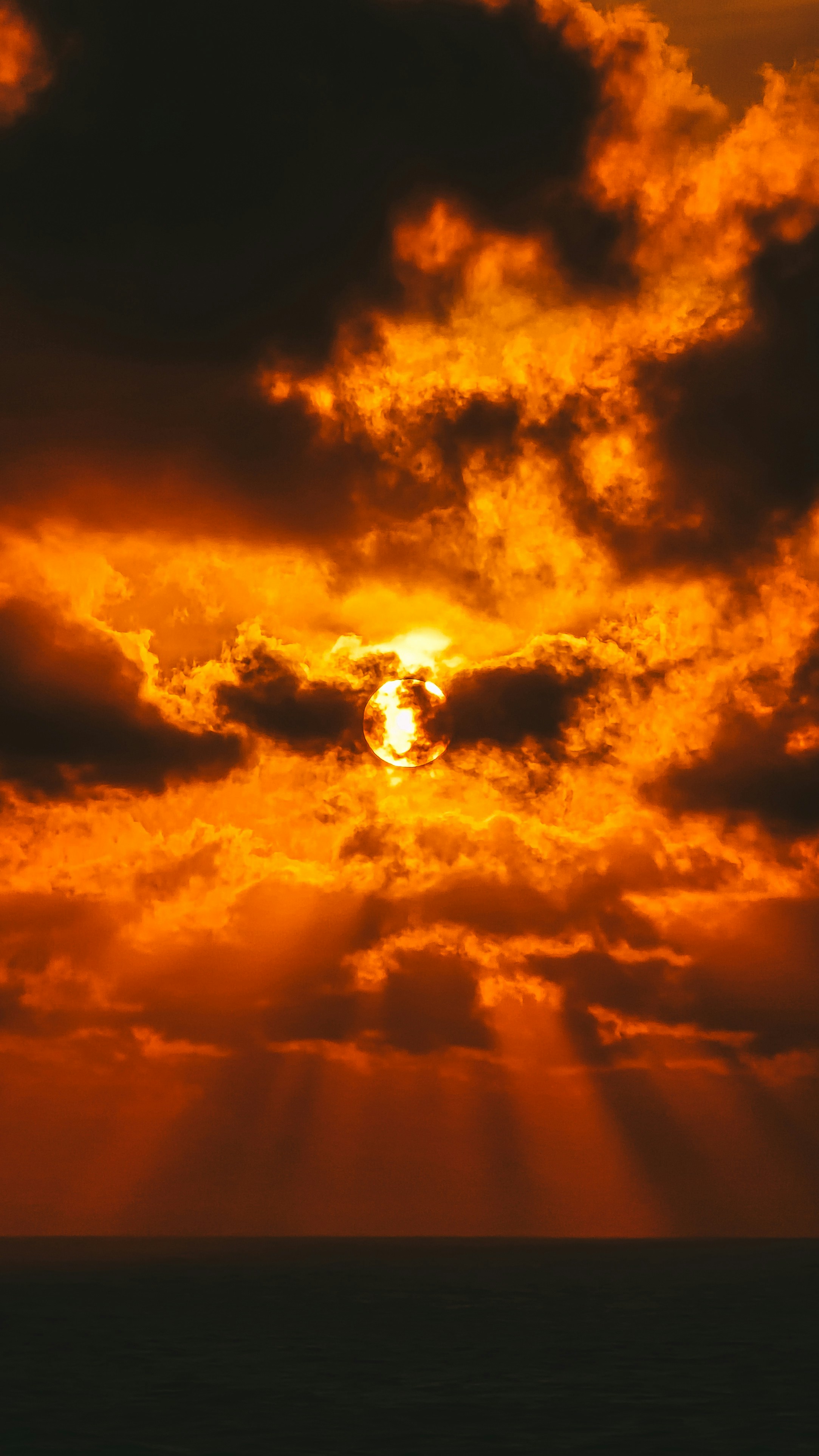 Sunfire at Sea: The Hidden Disk Amid Ridged Clouds