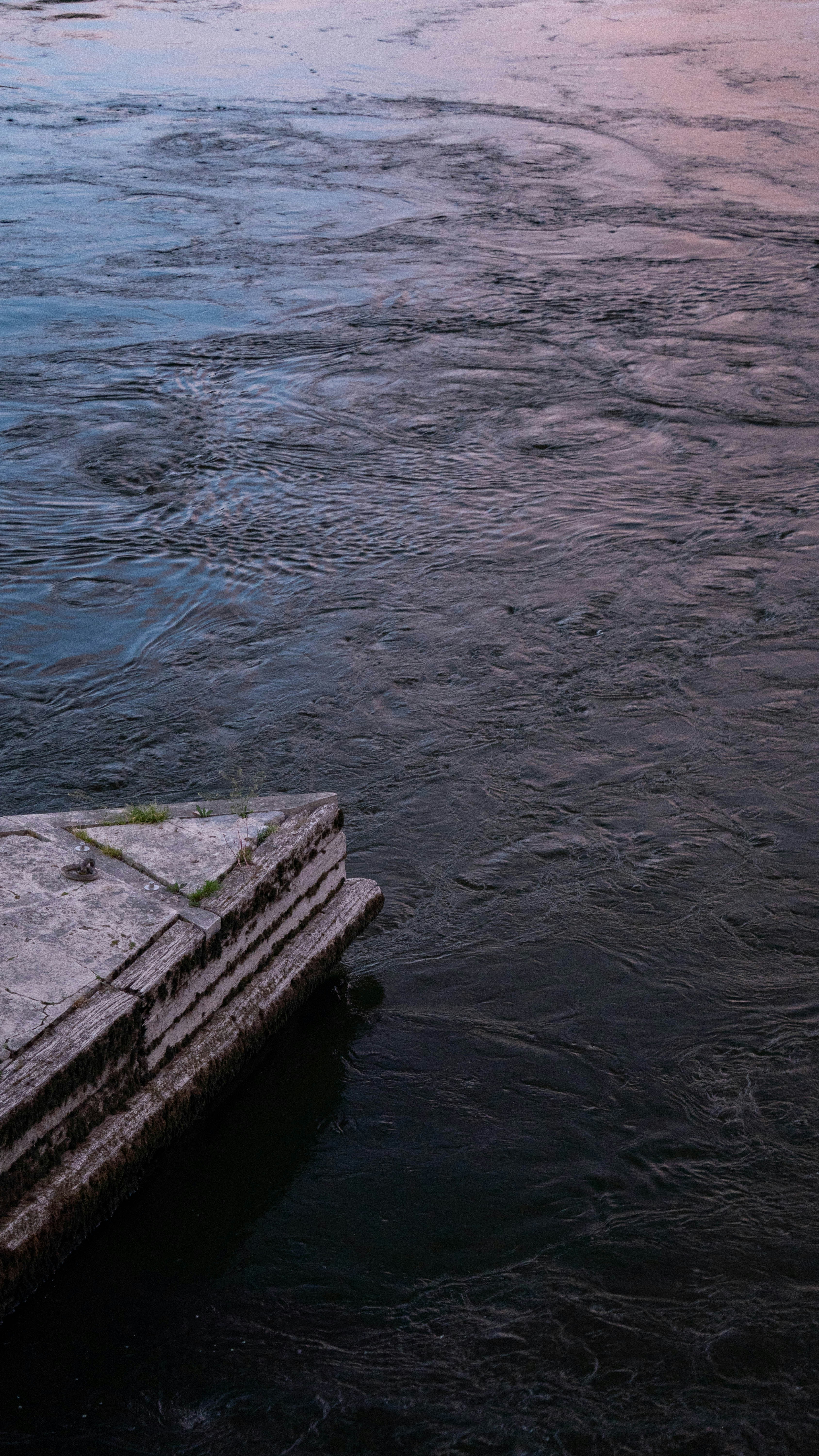 Edge of Quiet Water: A Concrete Pier in Dusk