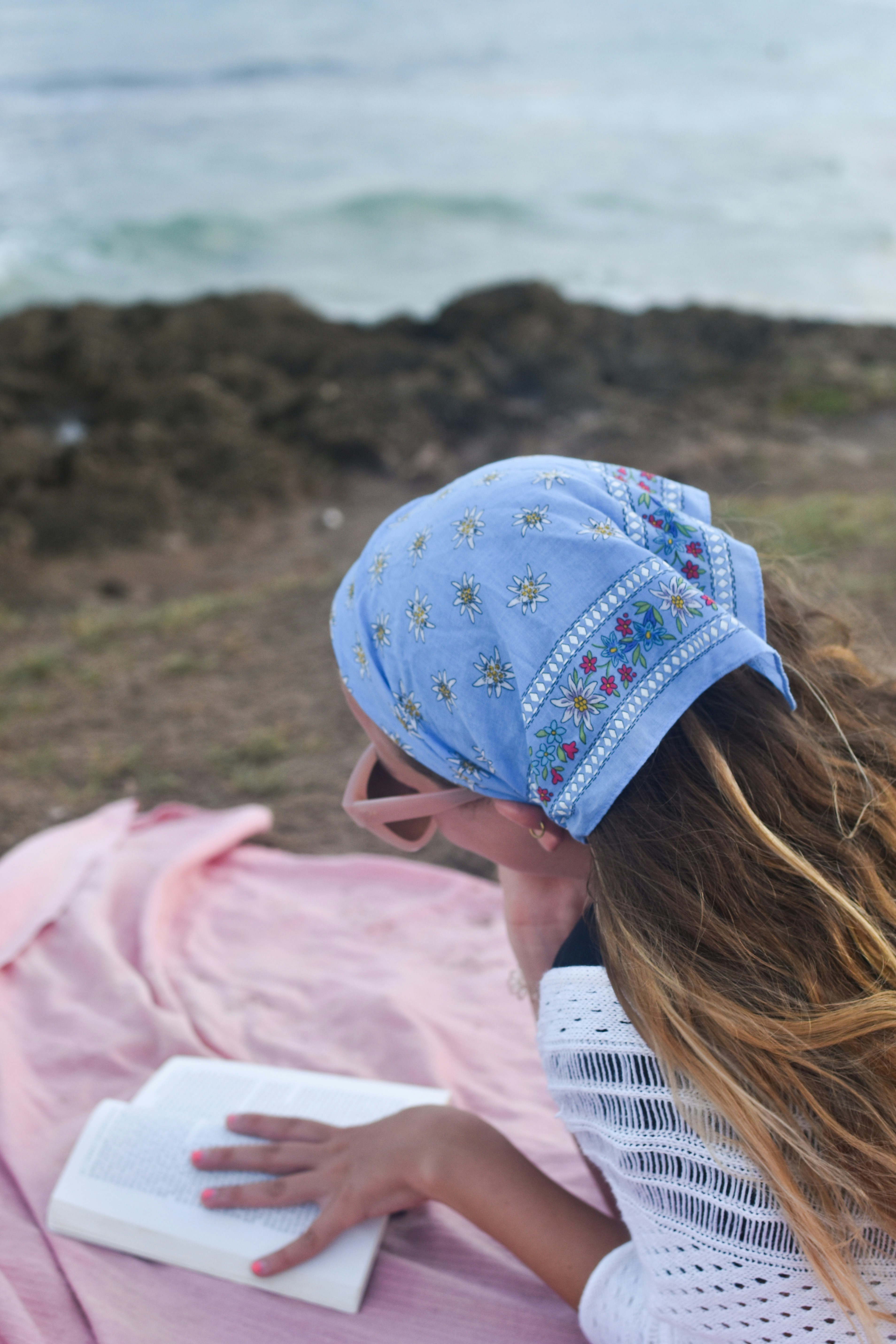 Blue bandana and sunlit reading on the seaside blanket