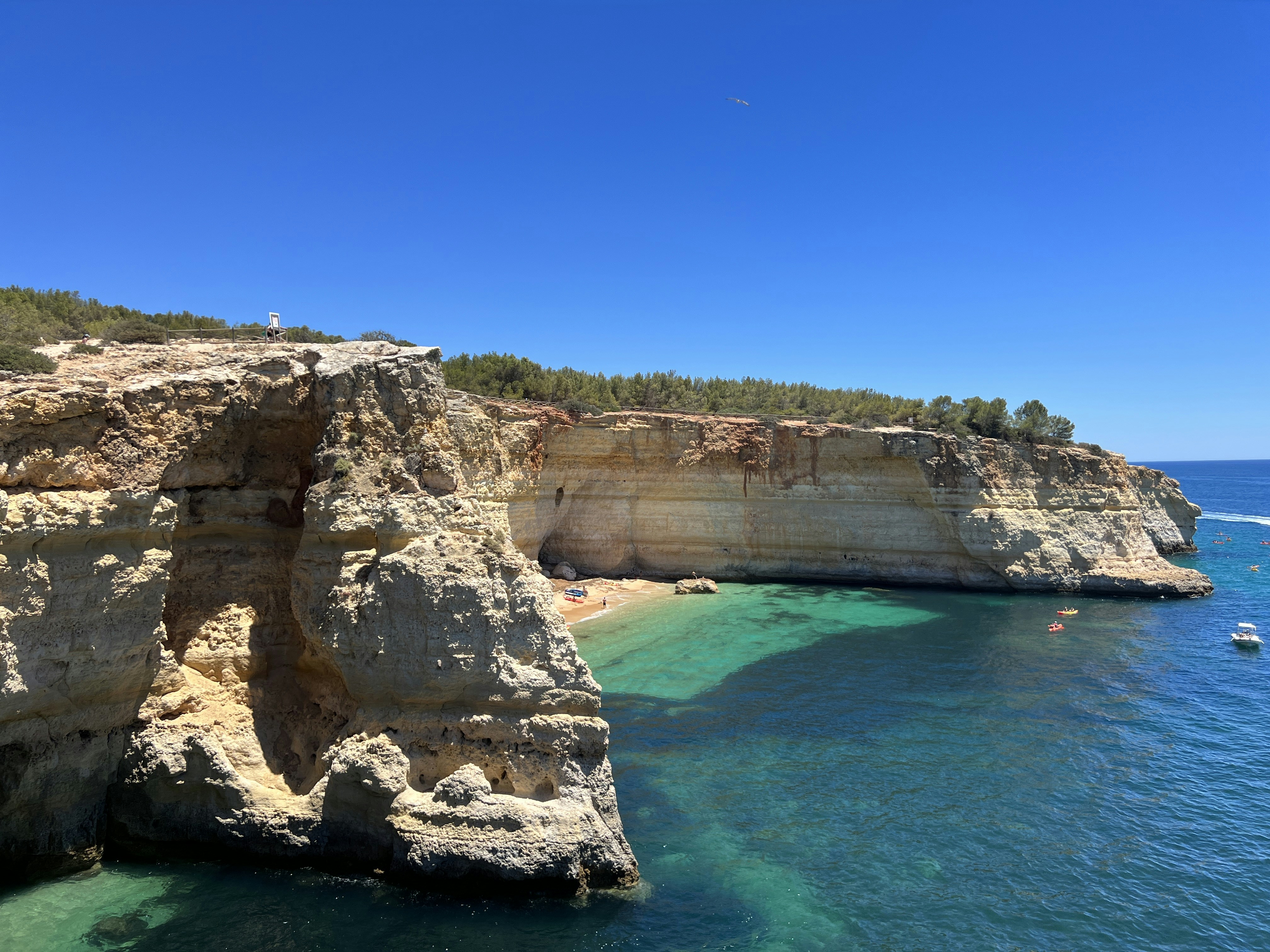 Coastal Cliffline and Turquoise Cove Under a Bold Sky