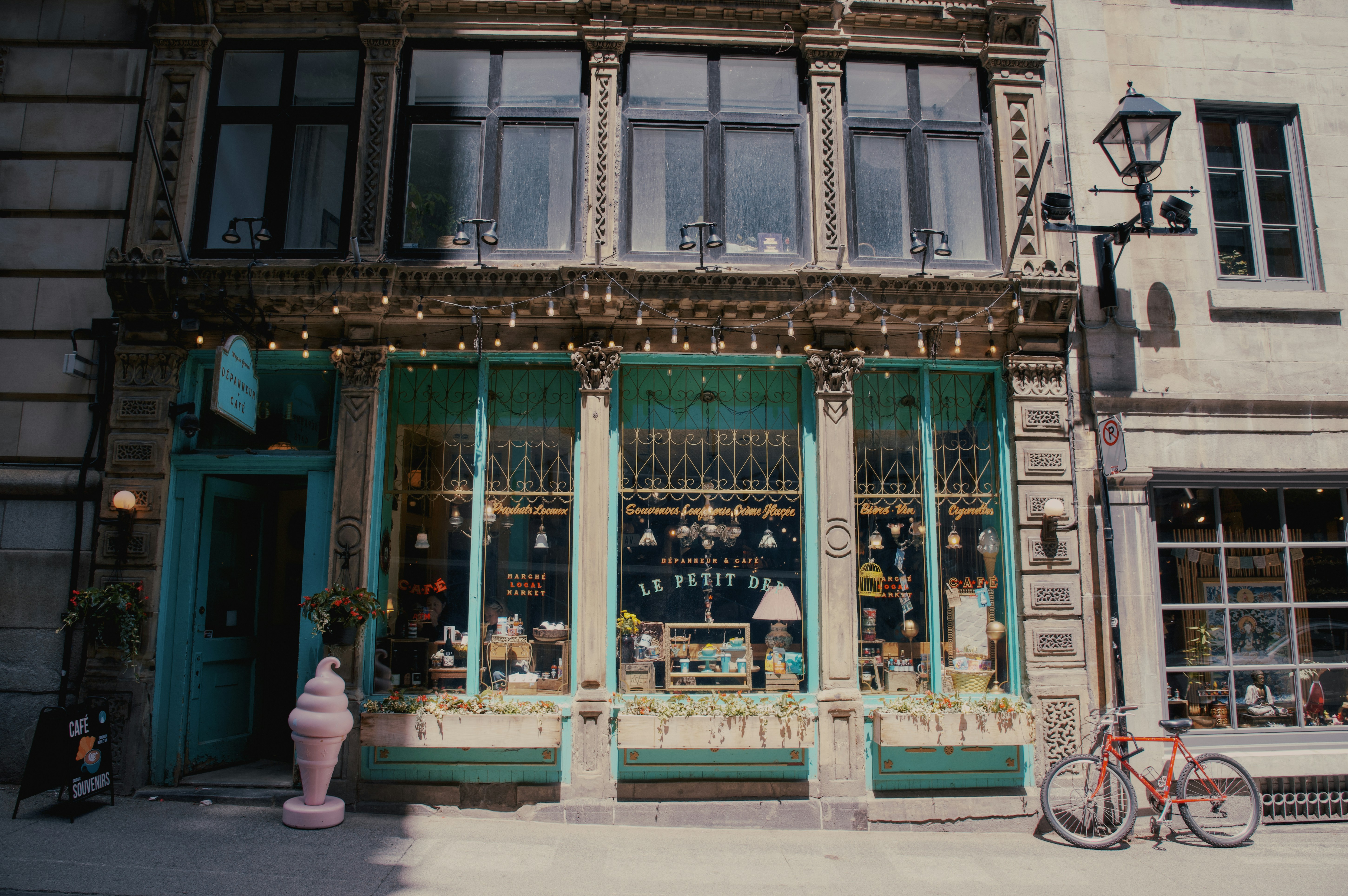 Pastel storefront glow: a charming green-awning bakery shop on a sunlit street