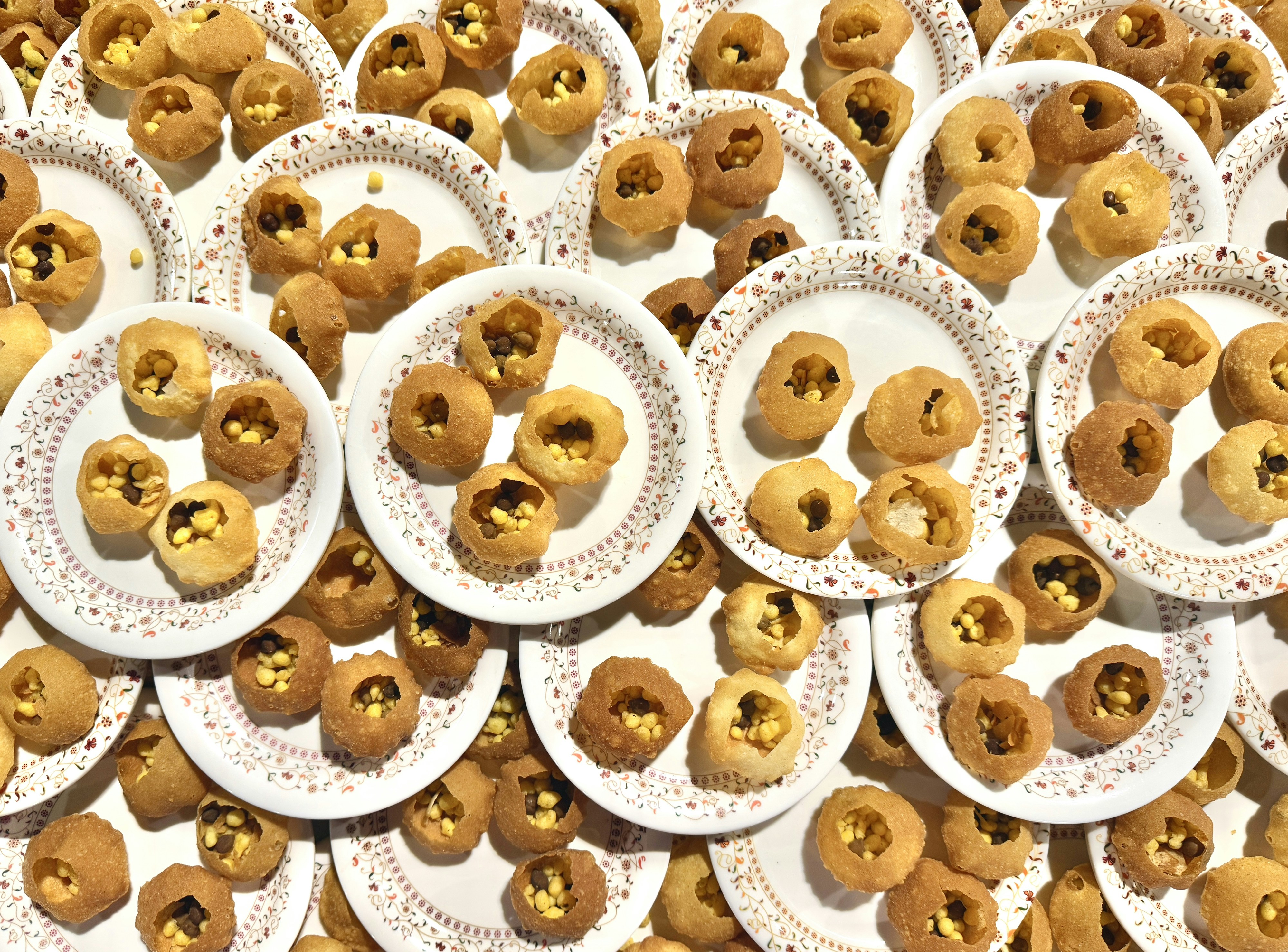Golden Pastry Orbs on Floral Rimmed Plates