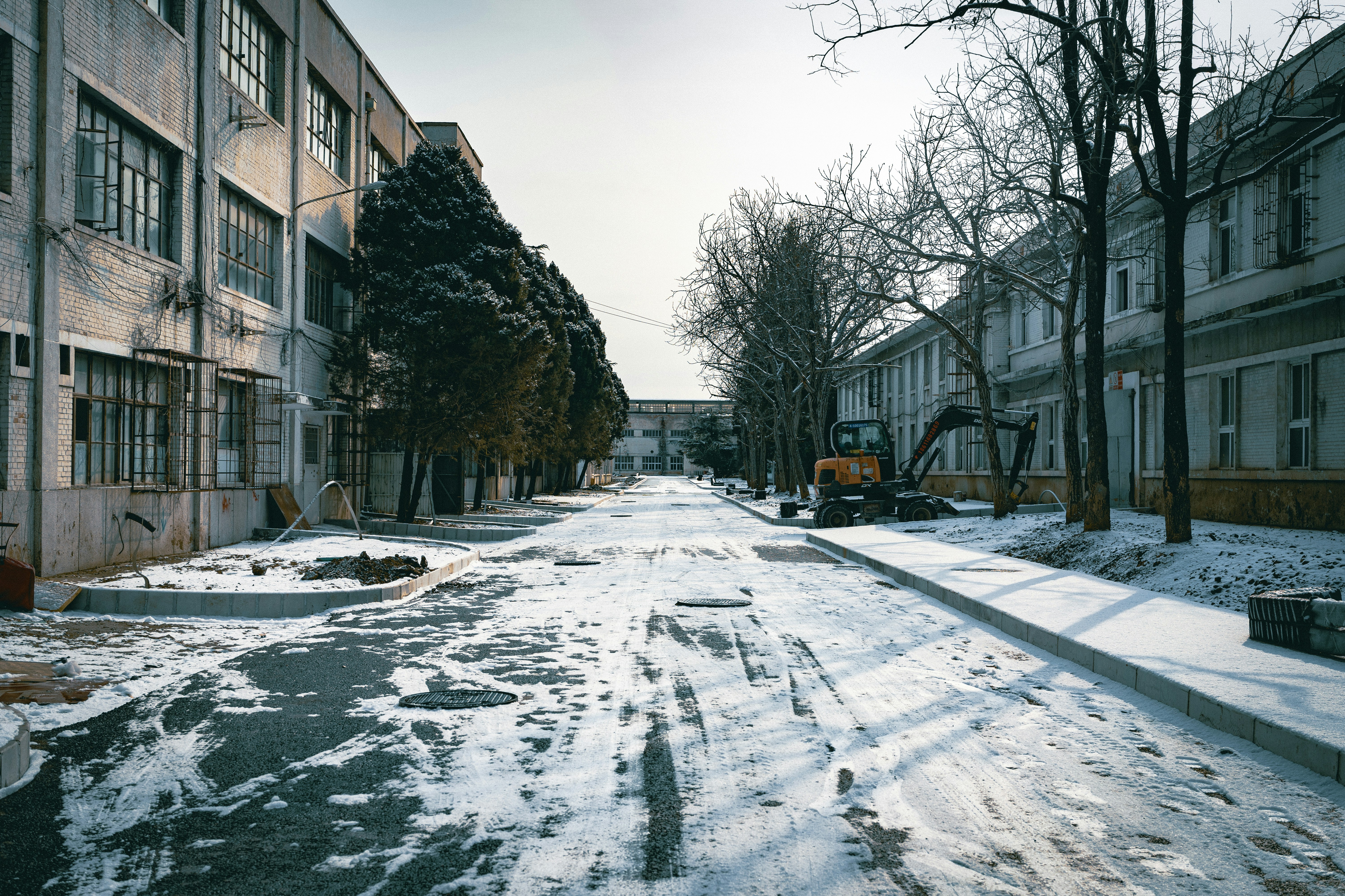 Snowbound Industrial Courtyard Quietly Recedes into the Distance