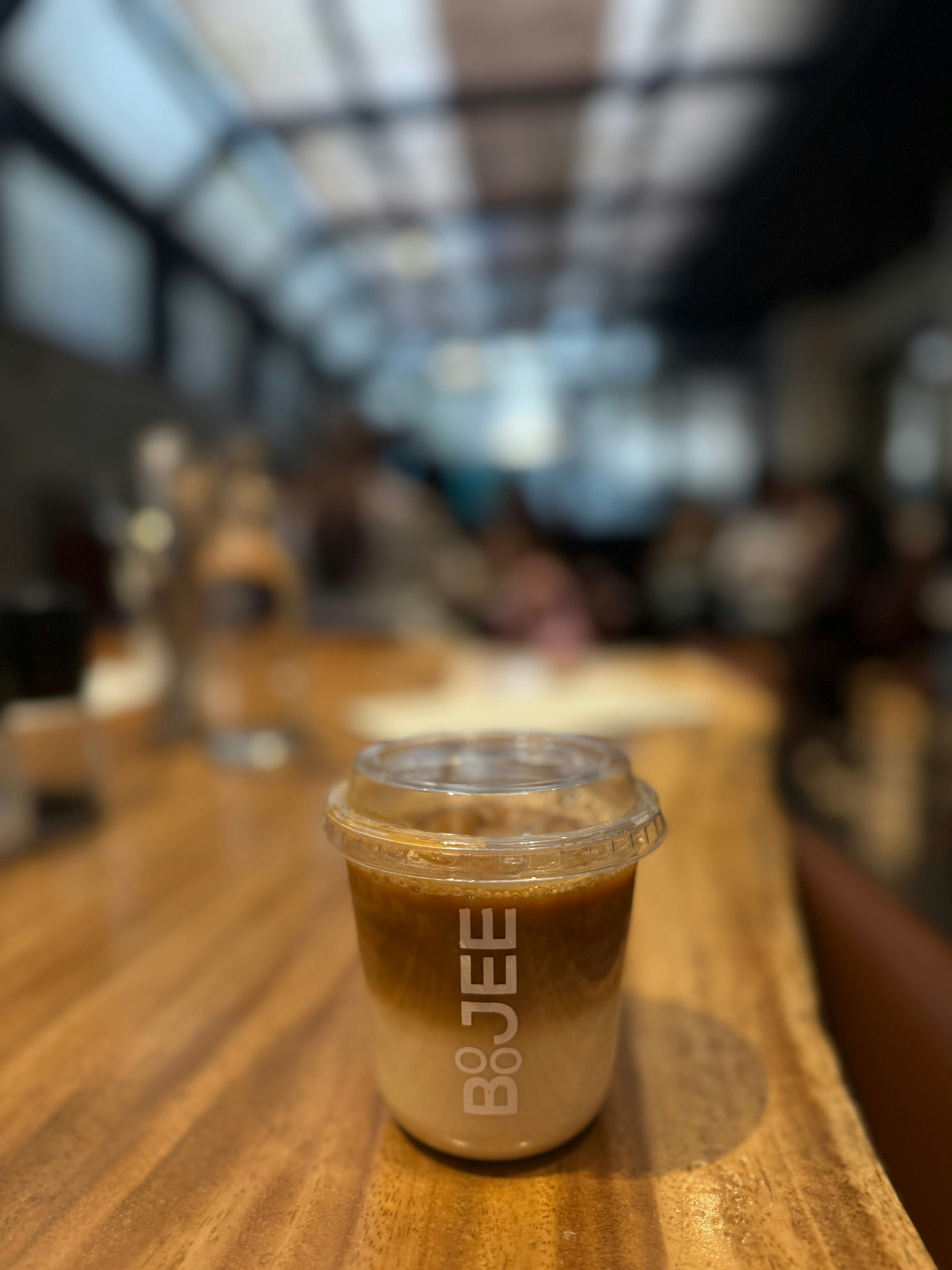 Centered Espresso: A Glass of Iced Coffee in a Cozy Café