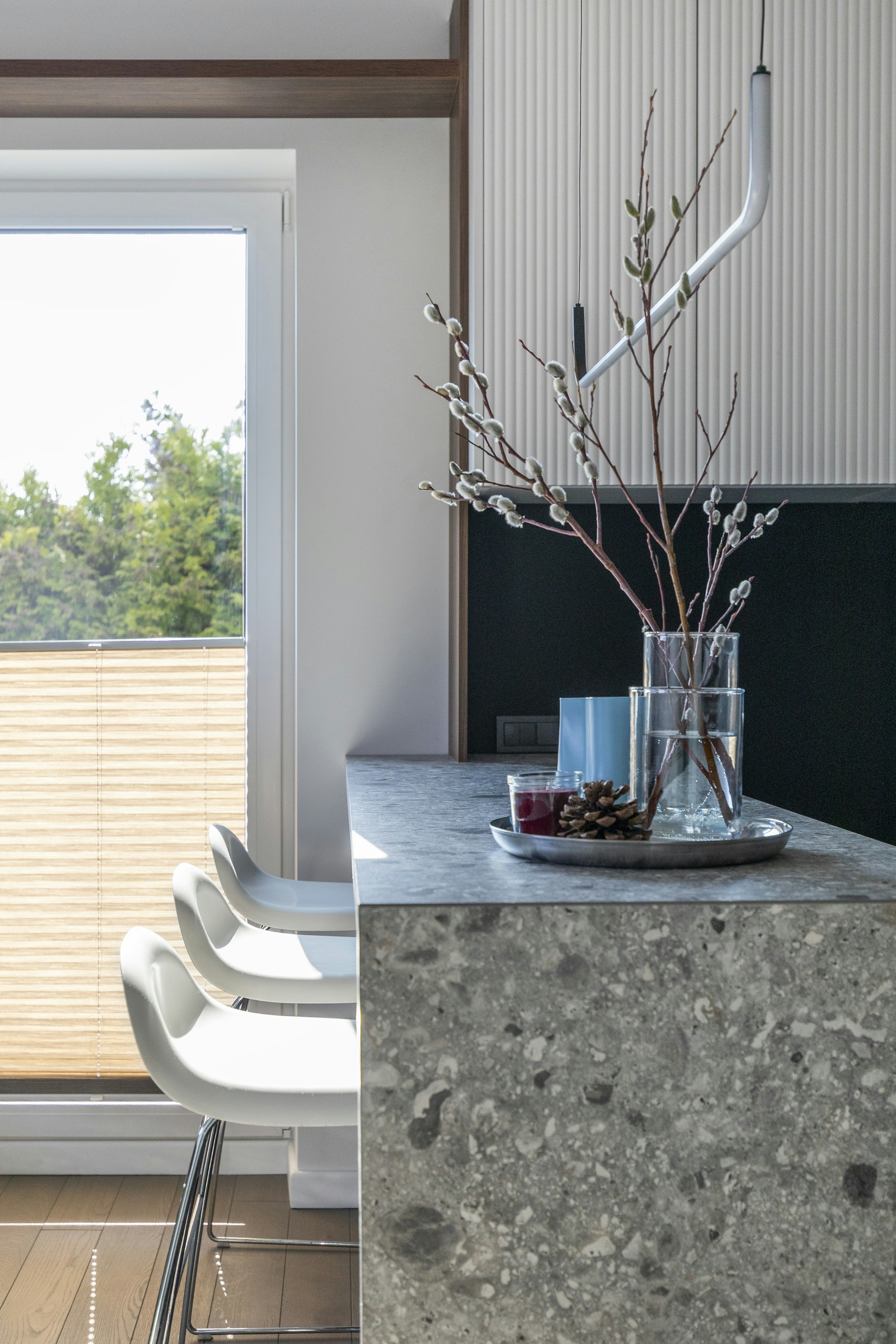 Pale Branches in a Concrete Kitchen: A Quiet Morning by the Bar