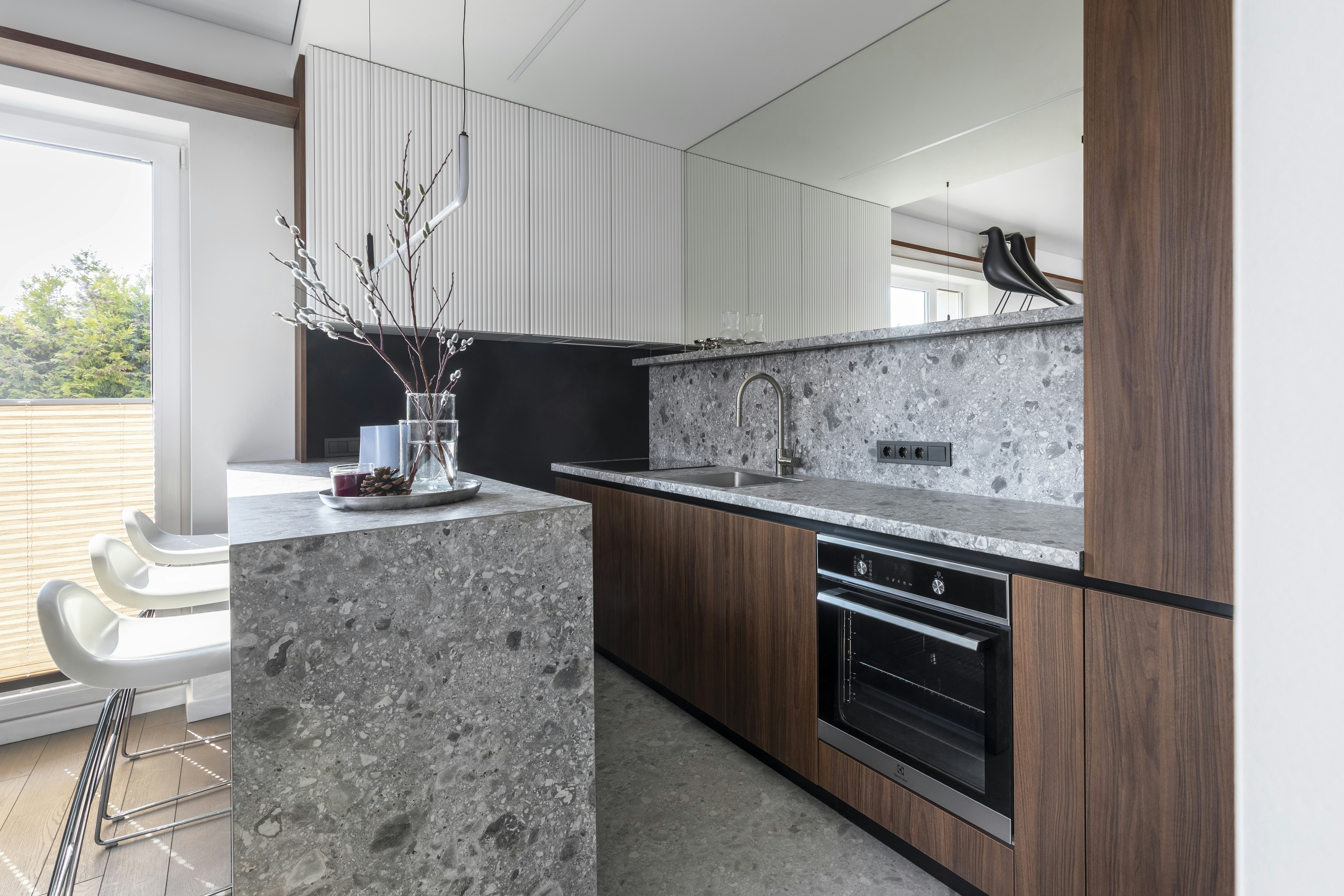 Minimalist Marble-and-Wrove Kitchen with Built-In Oven