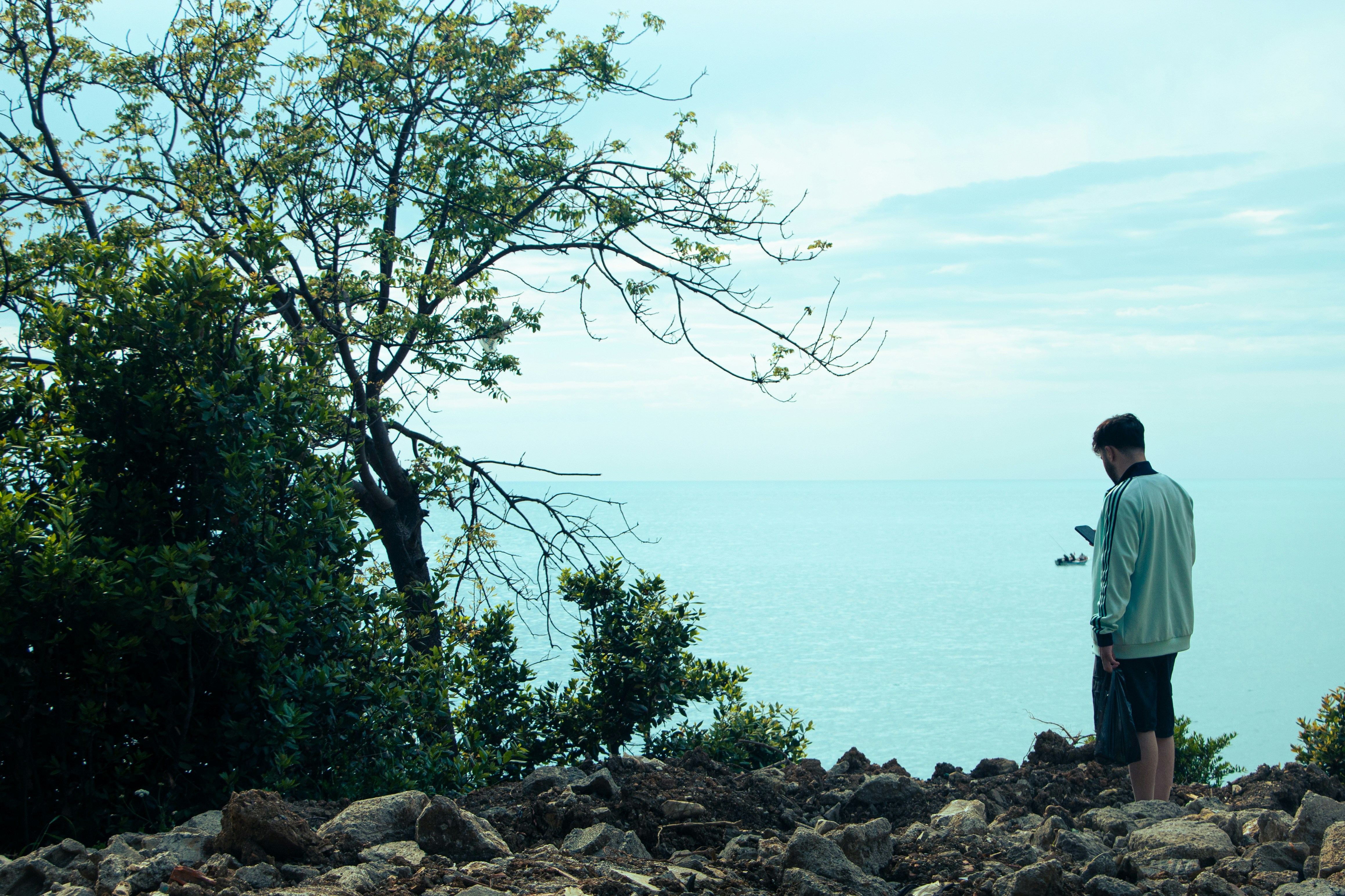 Seaside Cliffs: A lone figure micro-adjusts a drone at the edge of the world