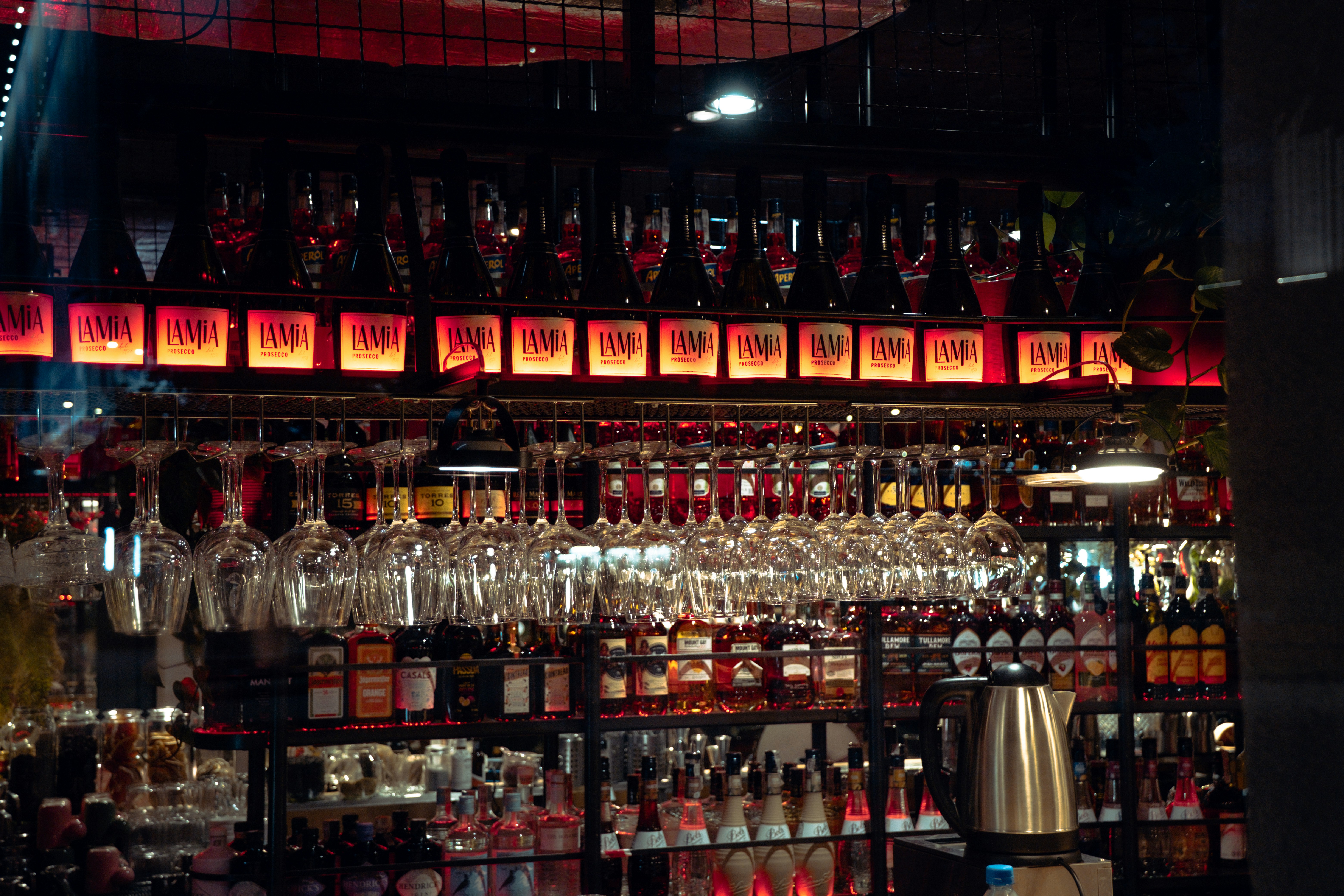 Neon Reflections Over a Liquor Shelf