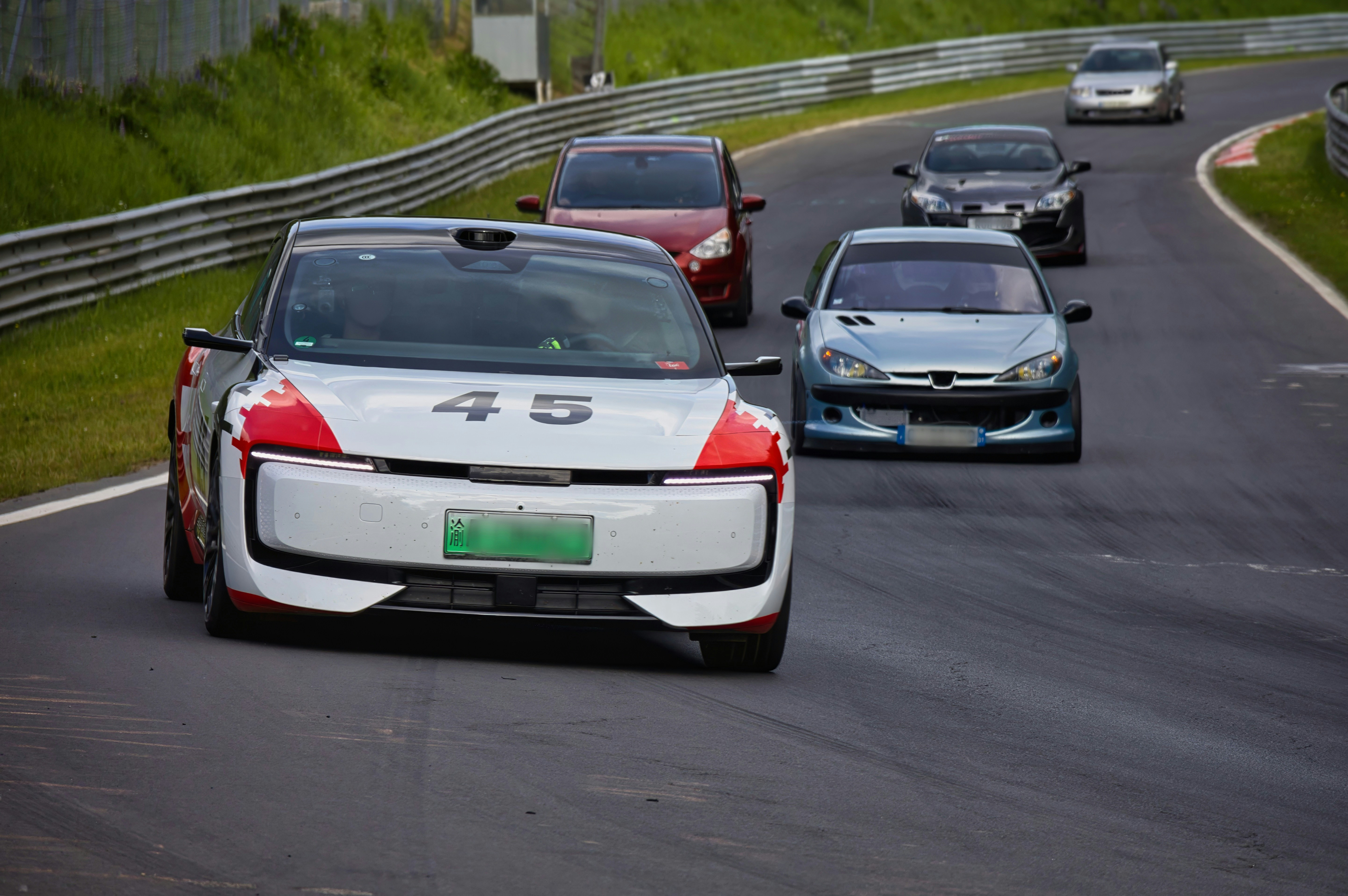 Lead White and red race car breaking away on a curving track