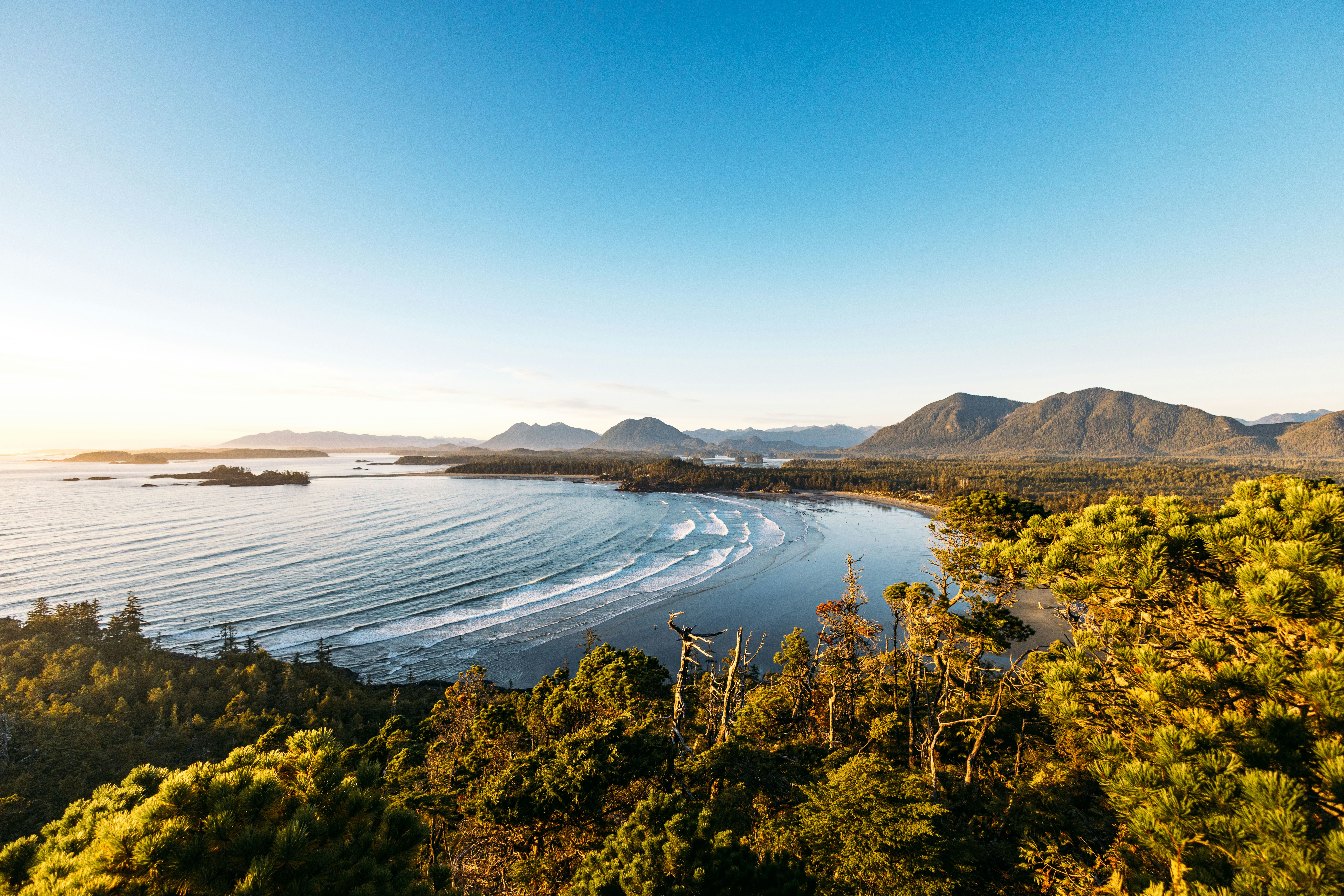 Coastal Panorama at Golden Hour: Cliffline, Sea, and Distant Peaks