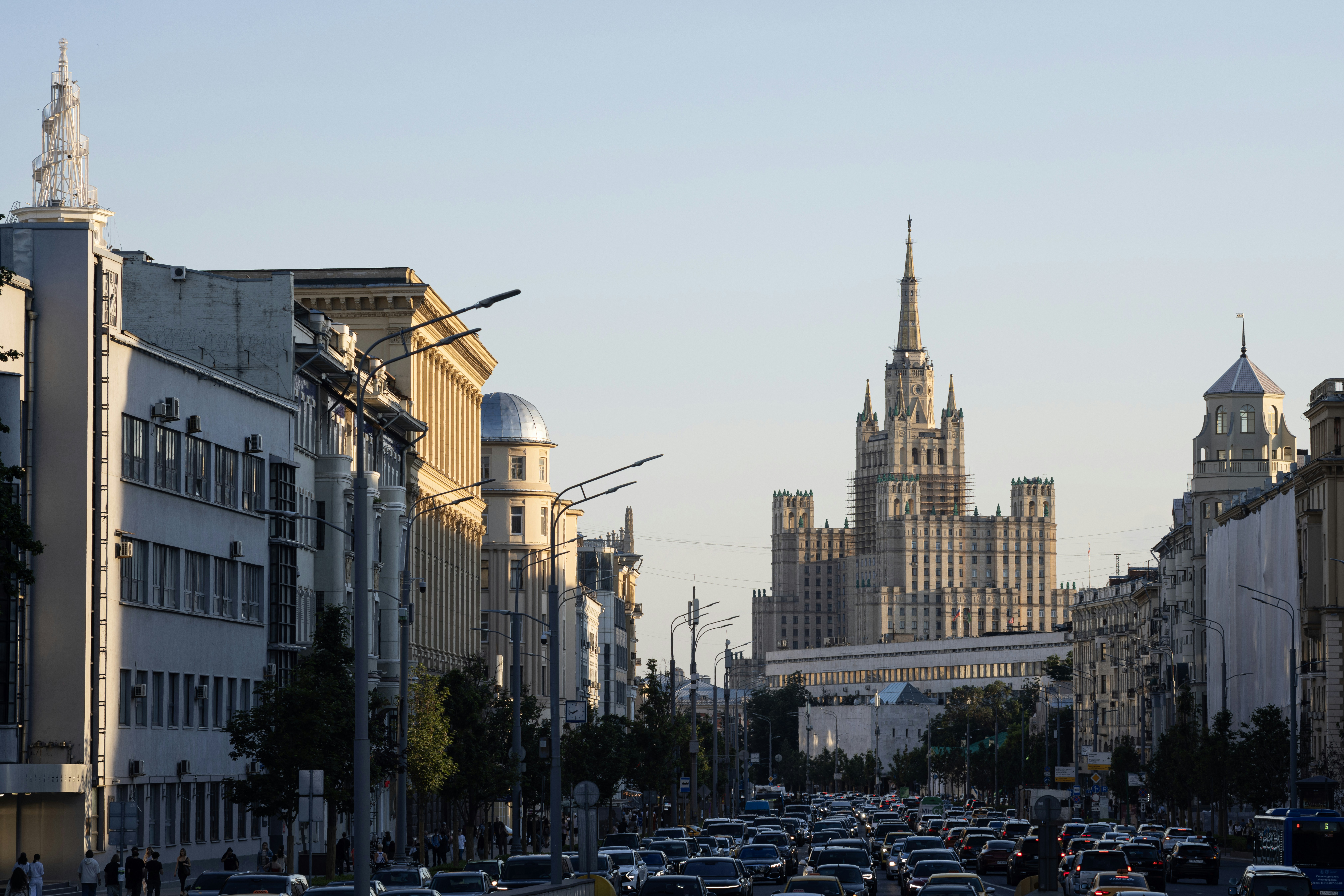 Midday Boulevard: A City’s Towering Silhouette Against a Busy Street