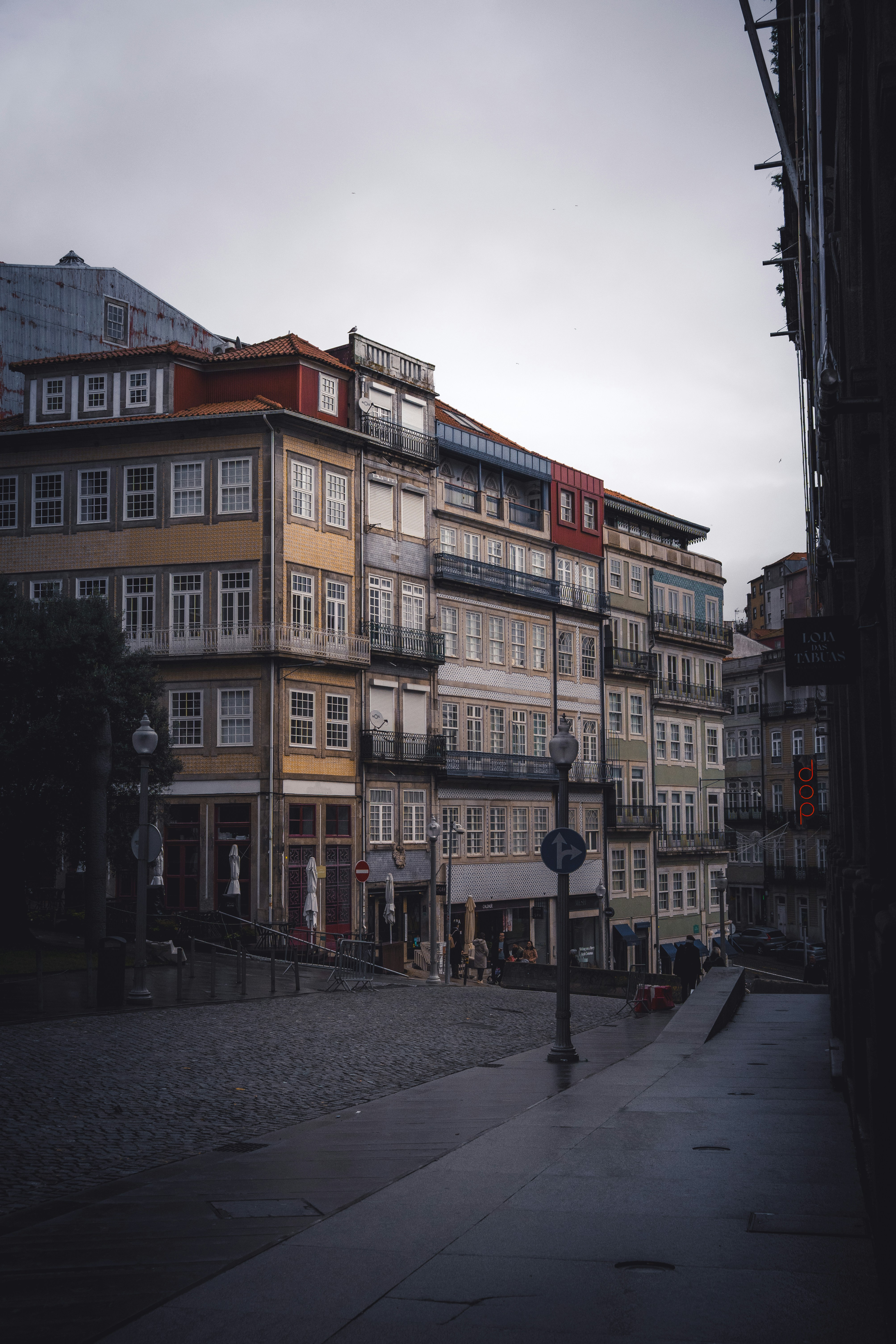 Colorful old buildings line a cobblestone street.
