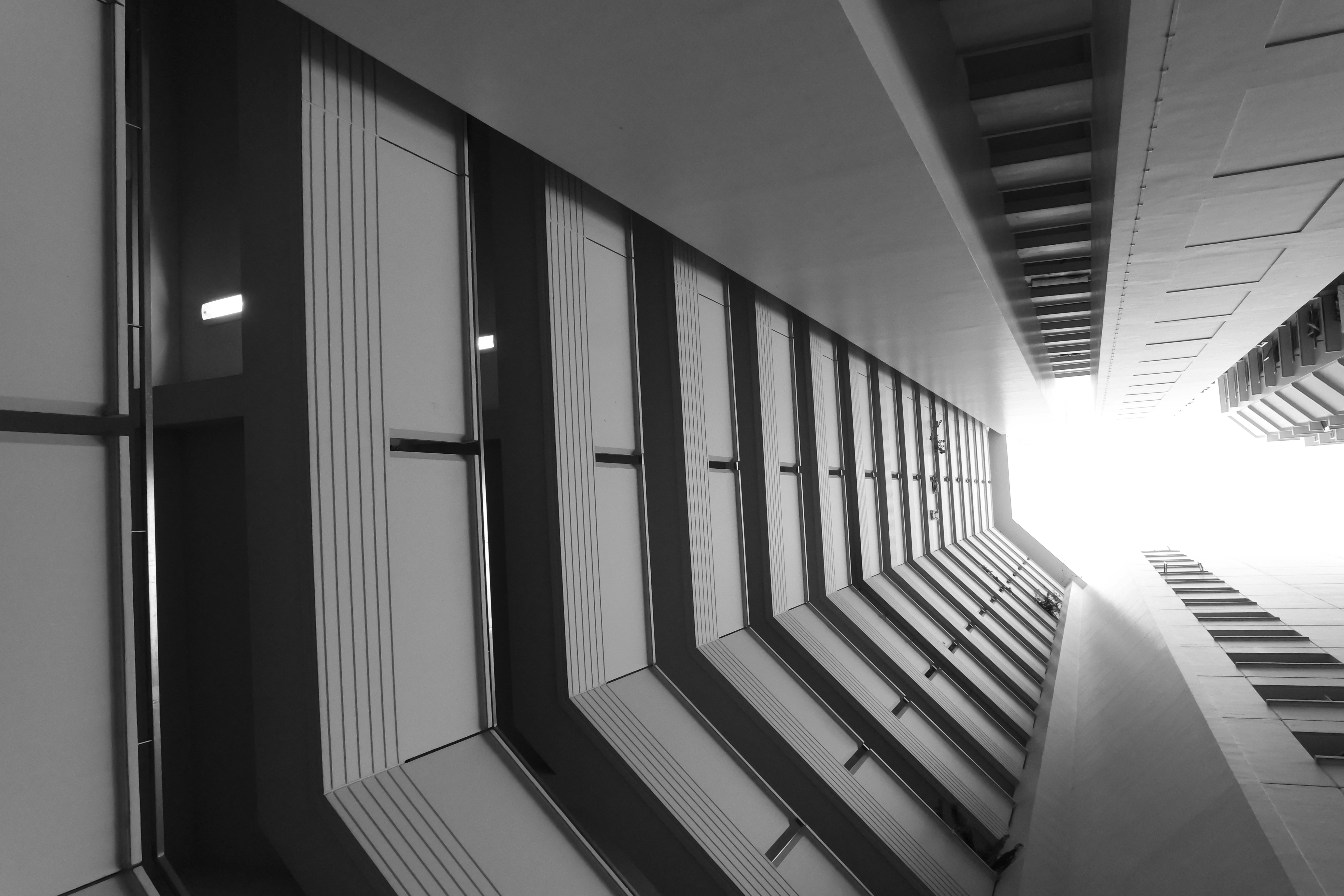 Vertical Skyward: A Bright Exit Amid Architectural Lines