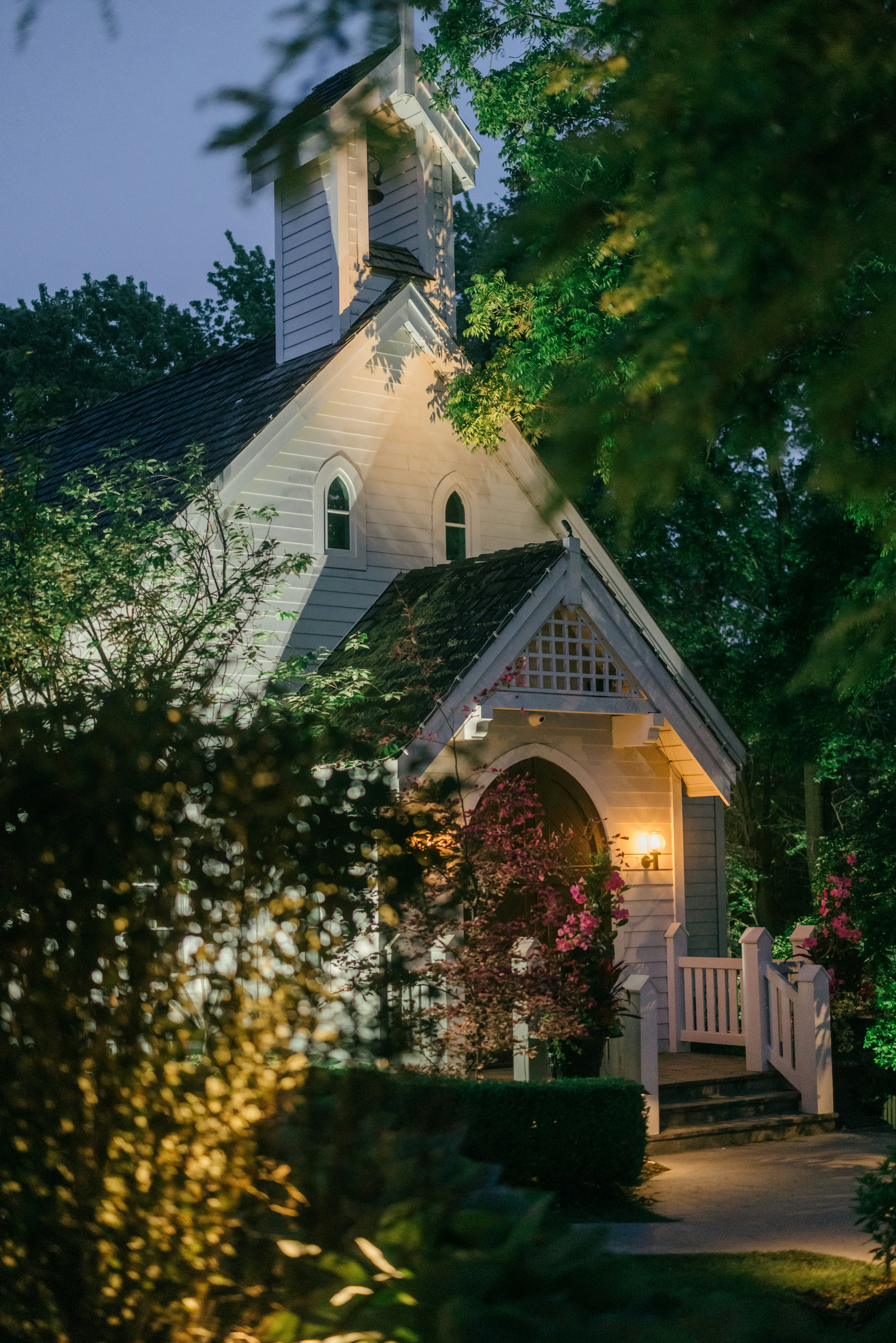 Charming White Chapel Nestled in Dusk-lit Garden