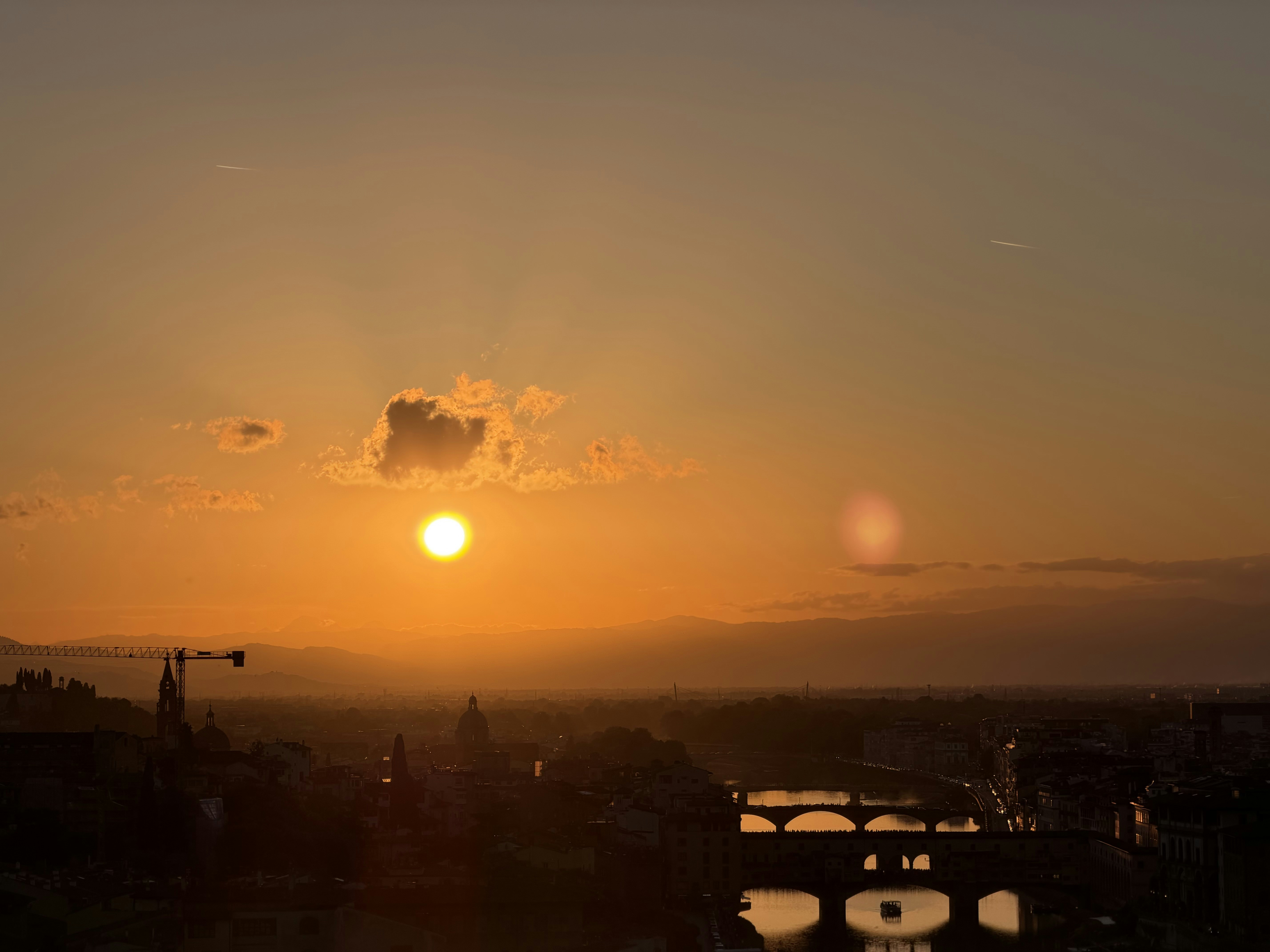 Golden Hour Over the River: City Silhouette at Sunset
