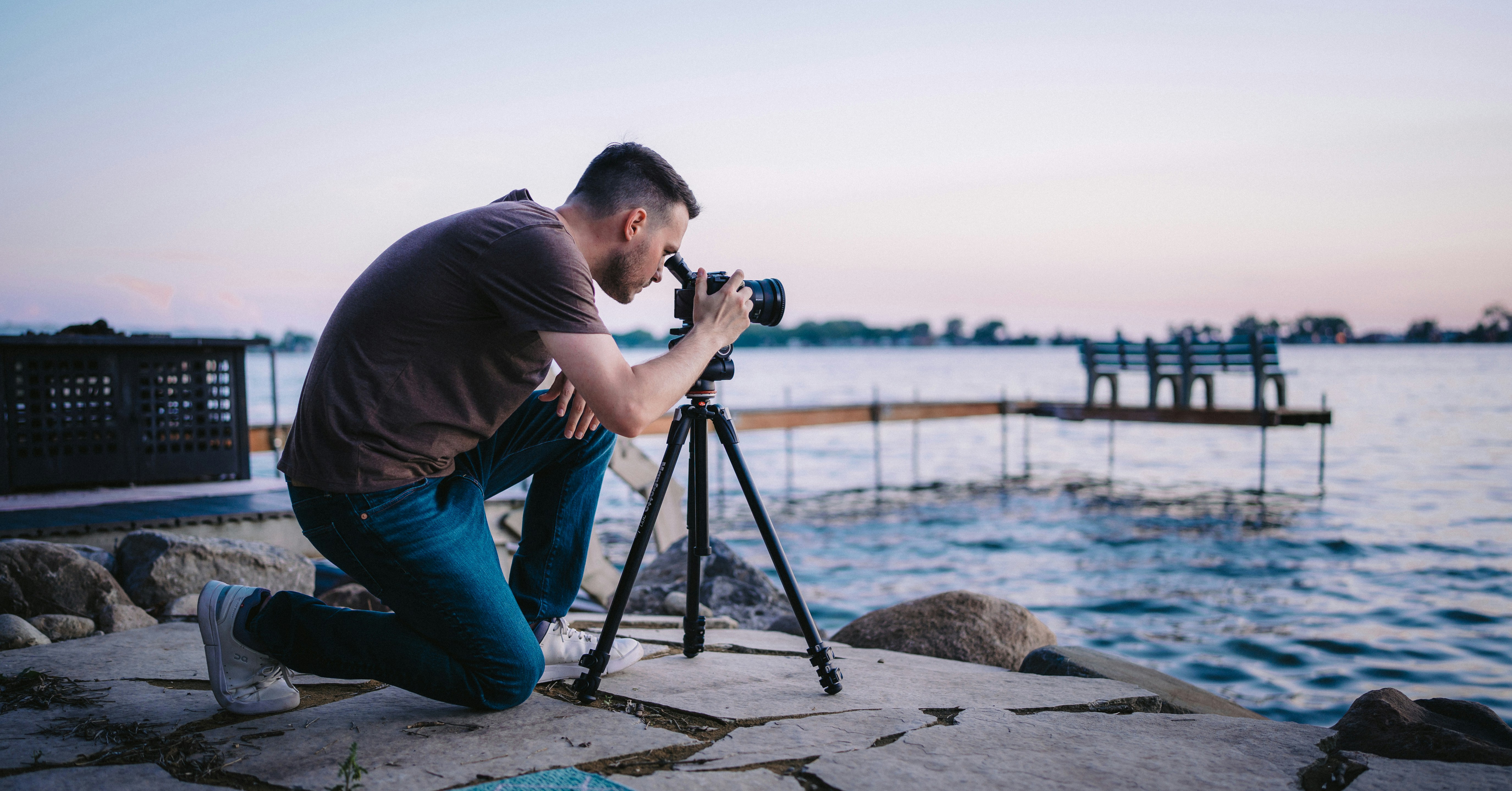 Lone Photographer at the Edge: Glassy Water and a Quiet Horizon