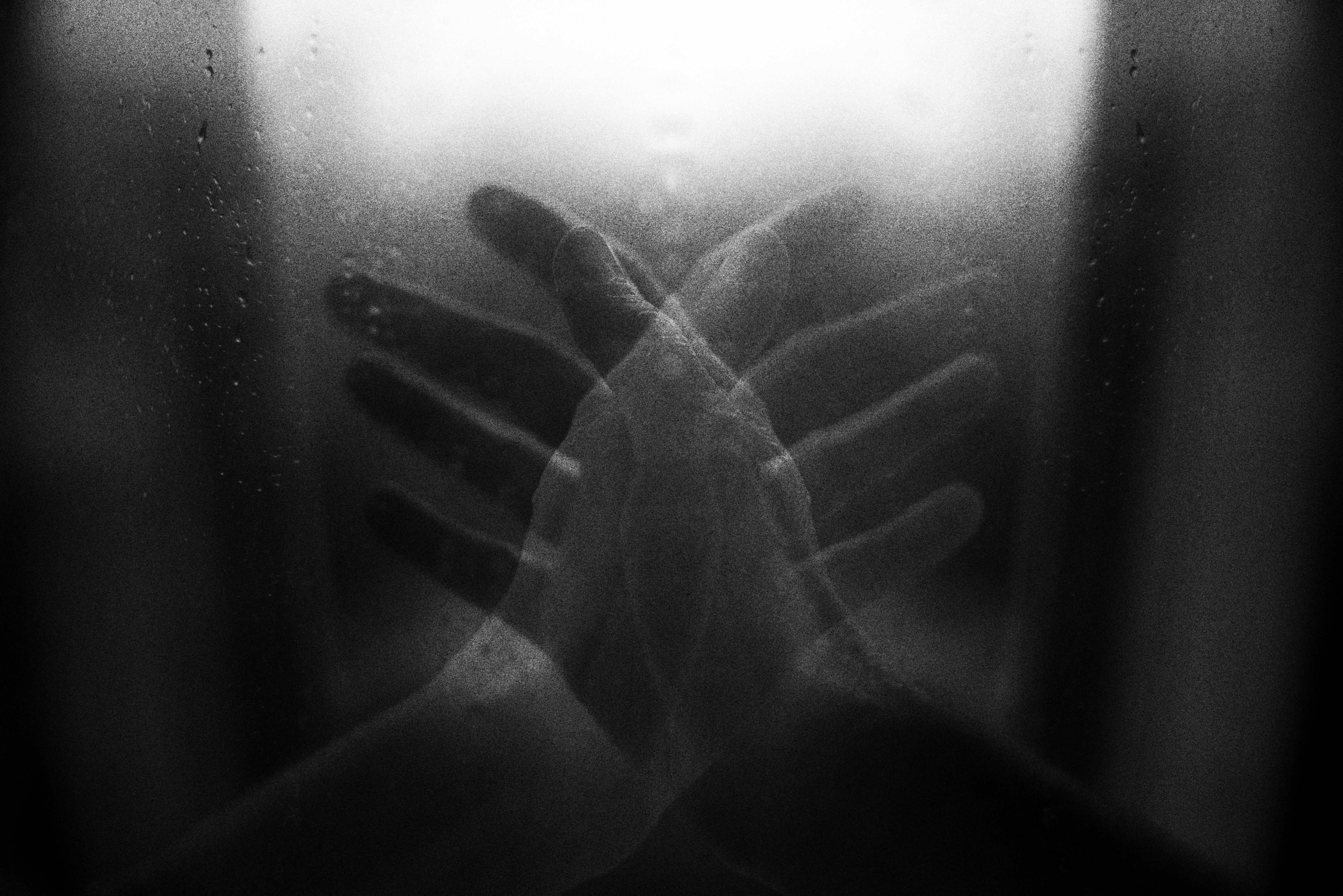 Hands Behind Glass: A Quiet Echo in Monochrome