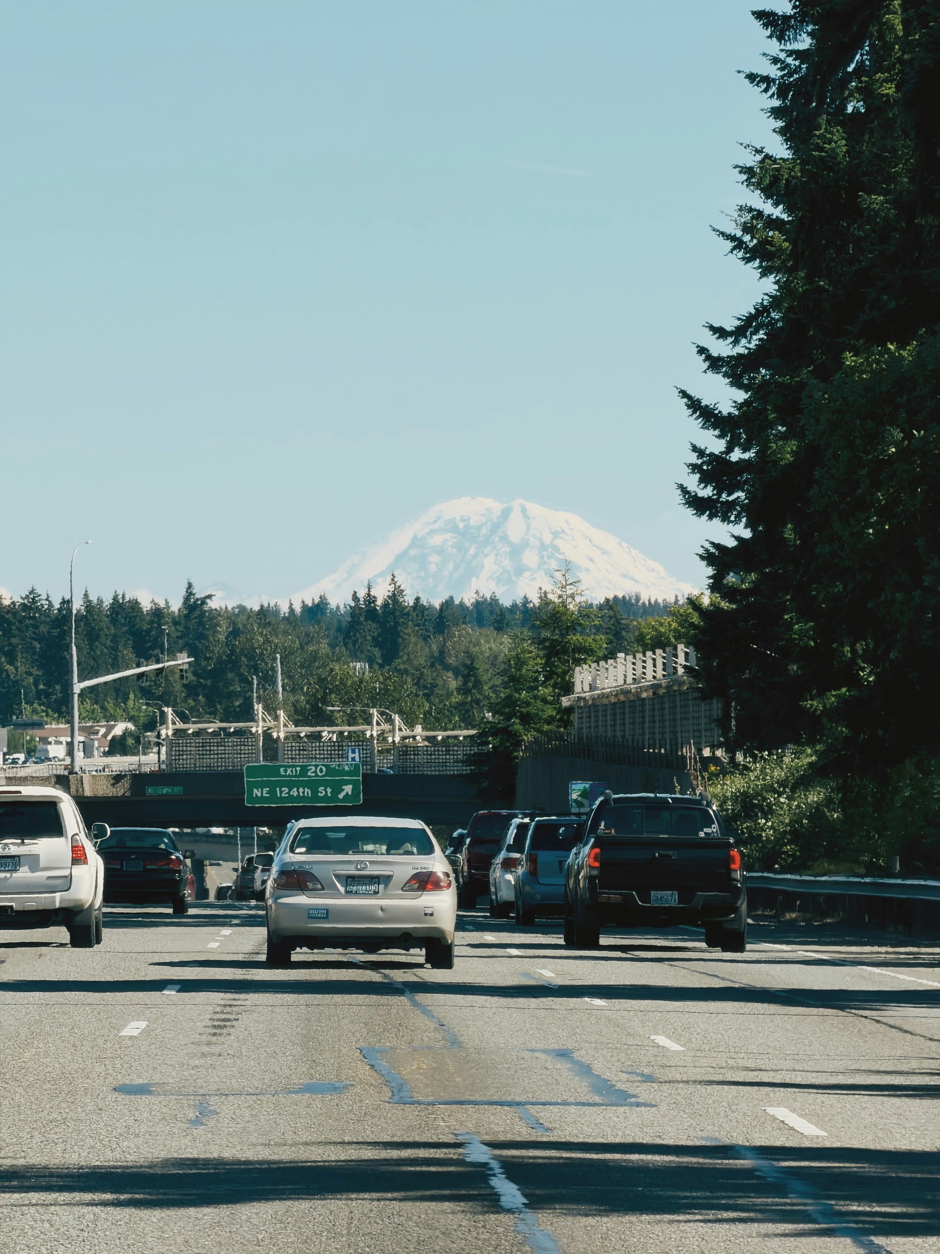 Mountaintop Commute: Snow Peak Above a Busy Highway