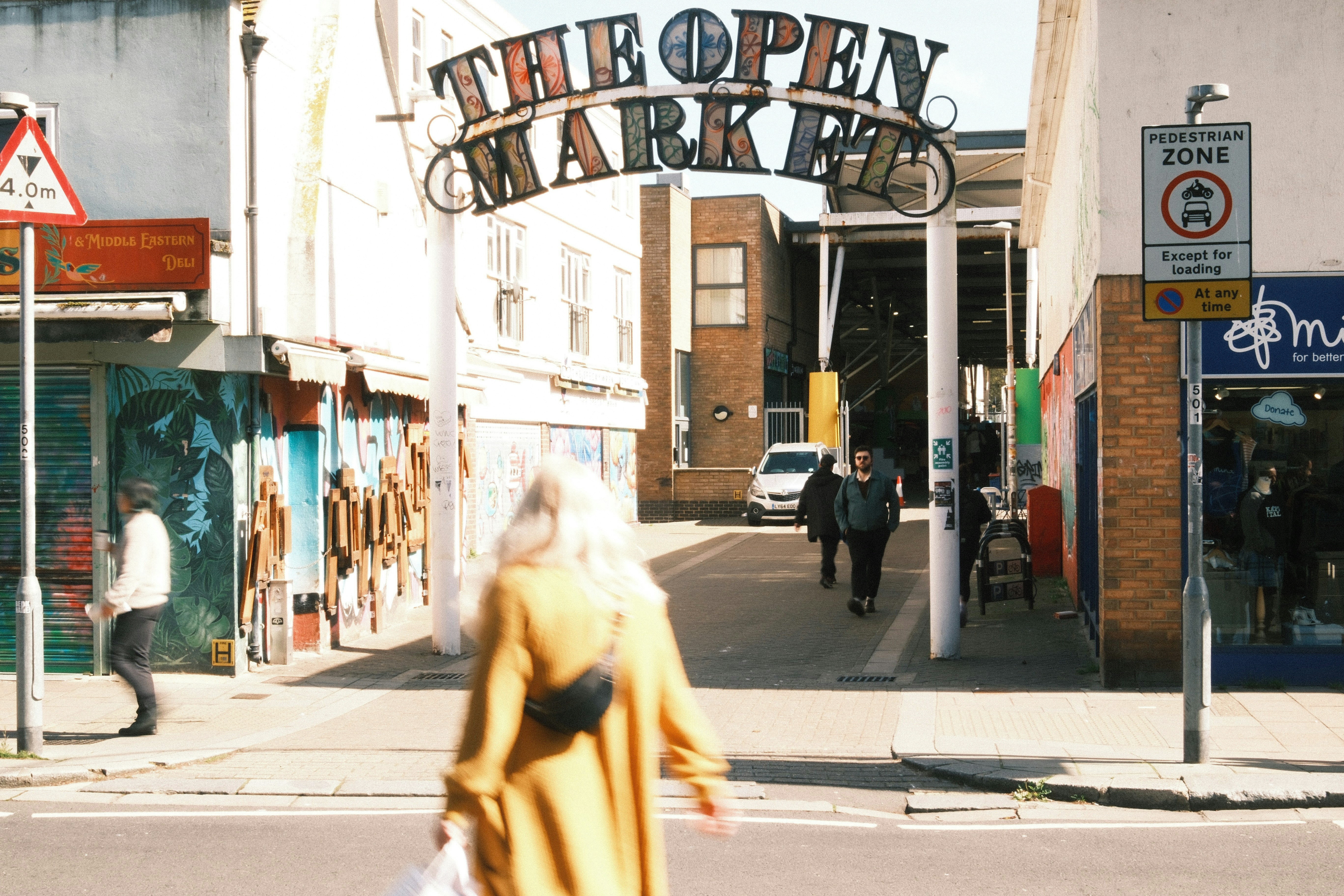 Open Market Archways: A Street Scene Framed by Light and Movement