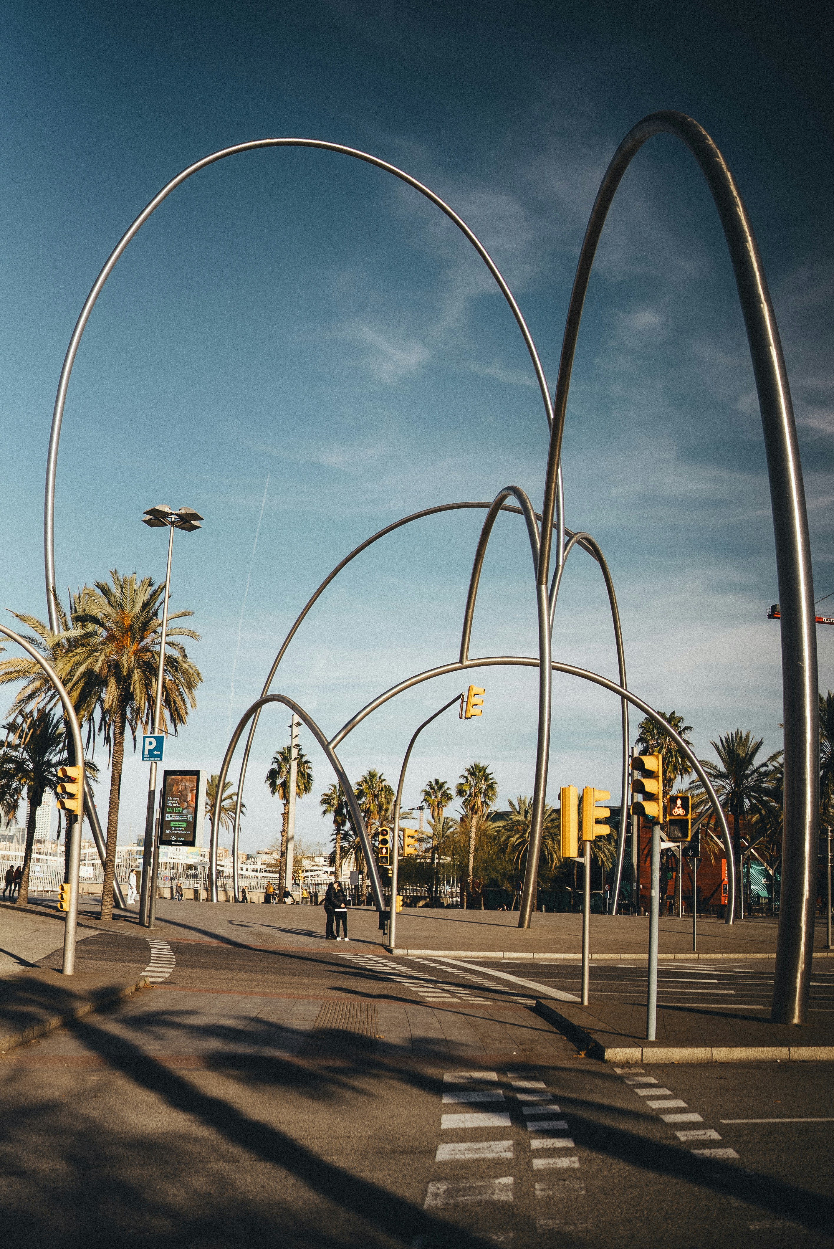Arcade of Steel Rings Over a Sunlit Boulevard