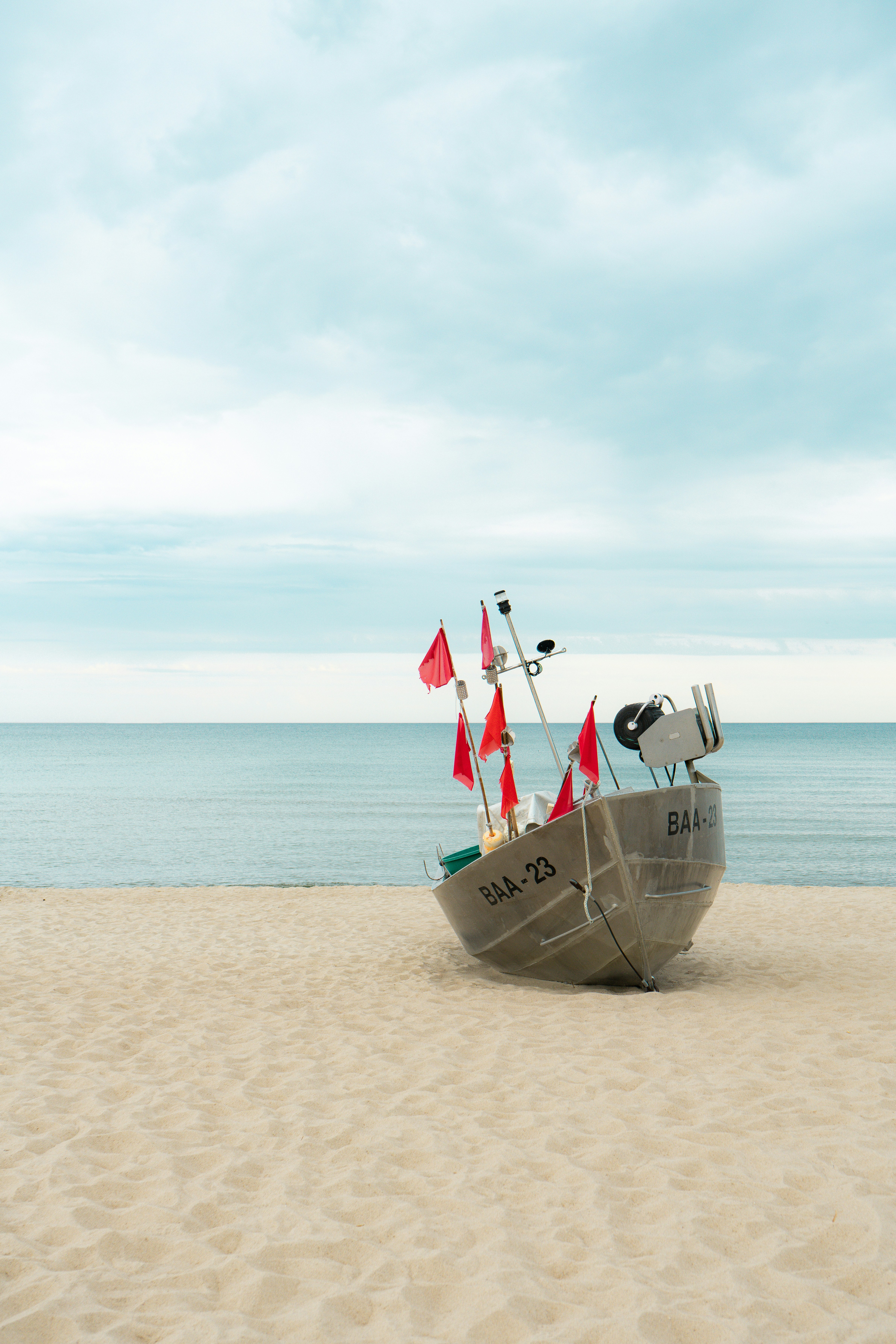 Beacon on the Quiet Shore: A Tilted Boat Resting at Dusk Beach