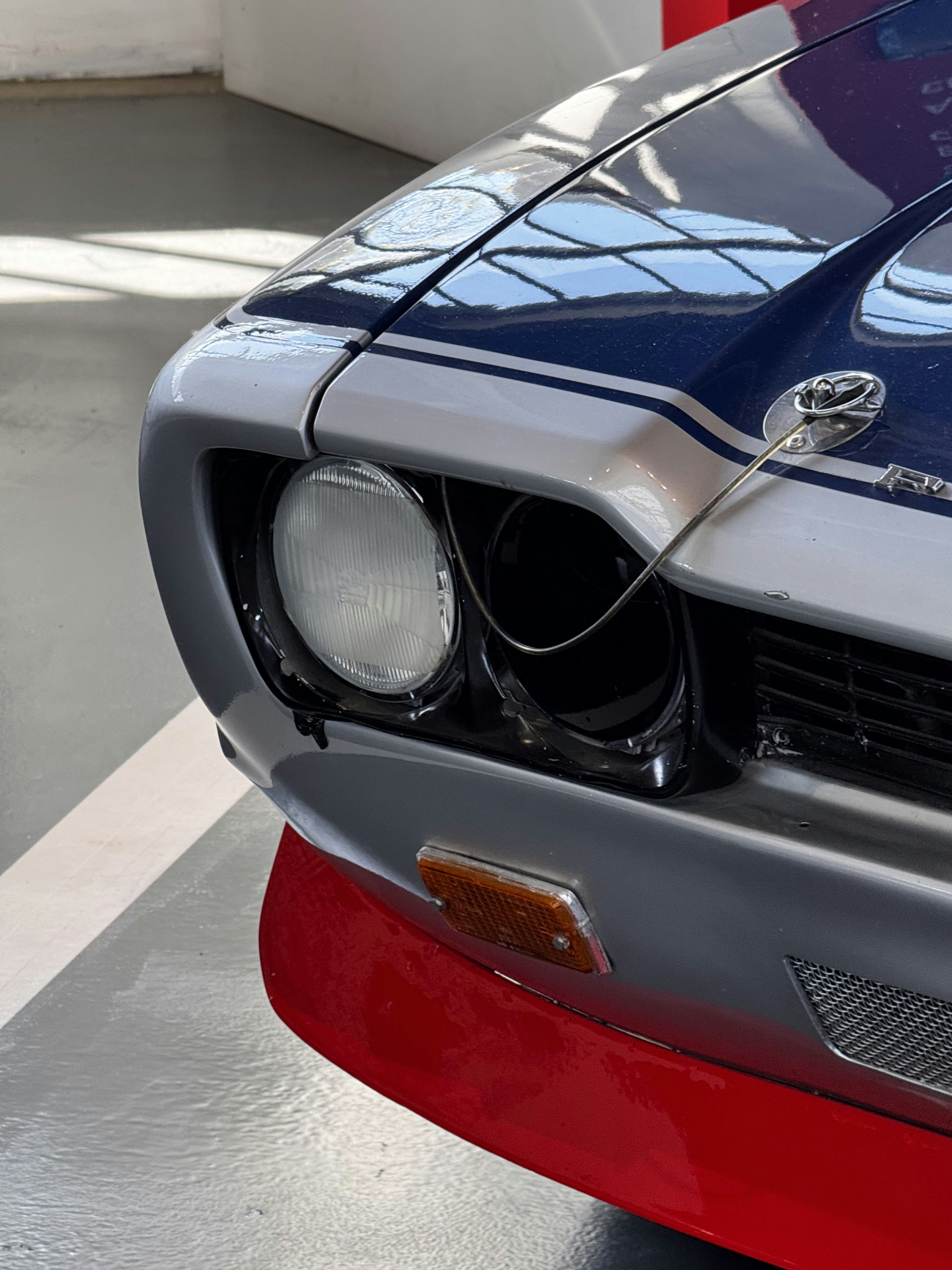 Front-Quarter of a Classic Rally Car: Headlamp and Hood Detail