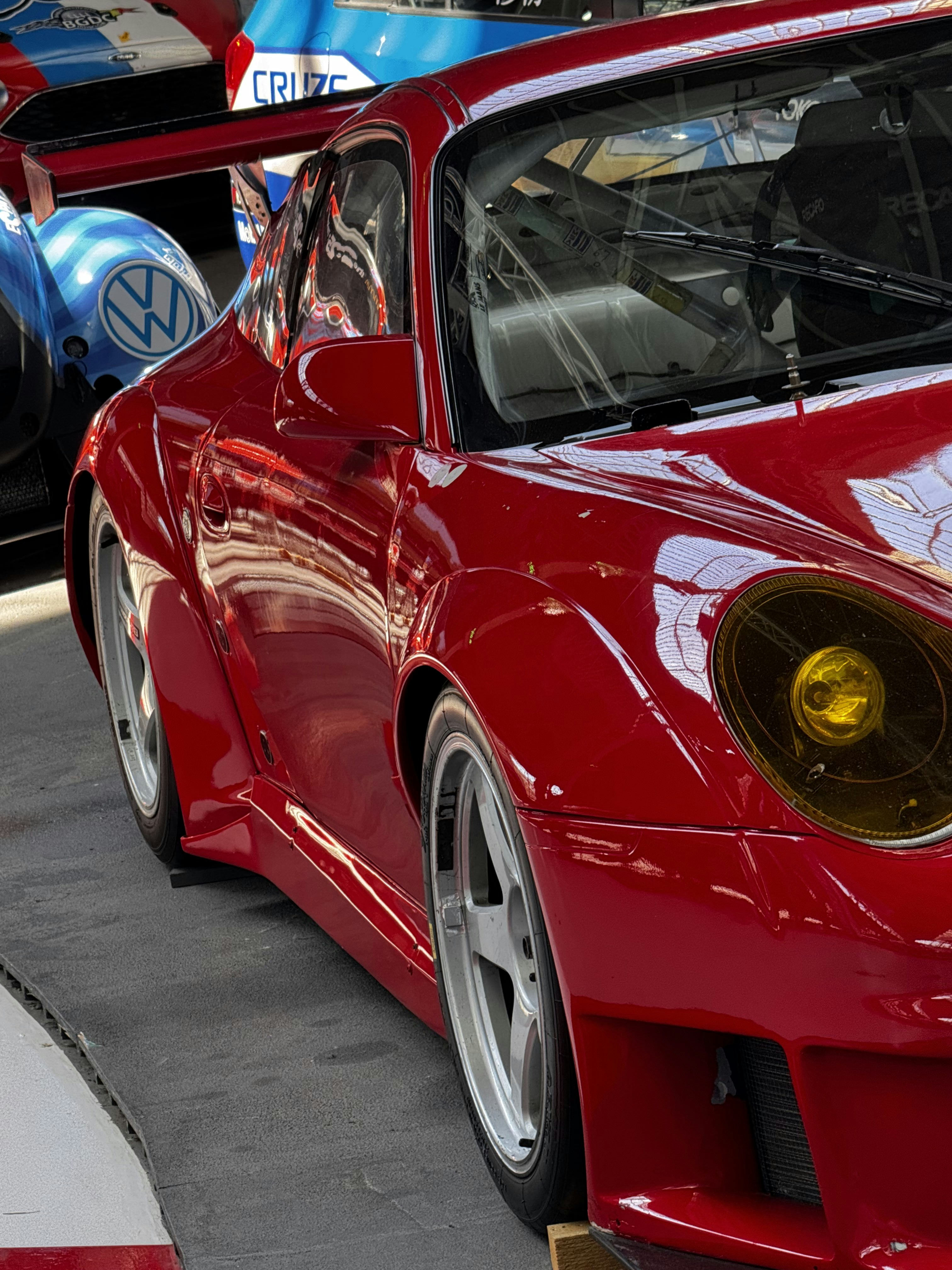 Red Ferrari silhouette: a close-up of curves and glossy paint at a car show