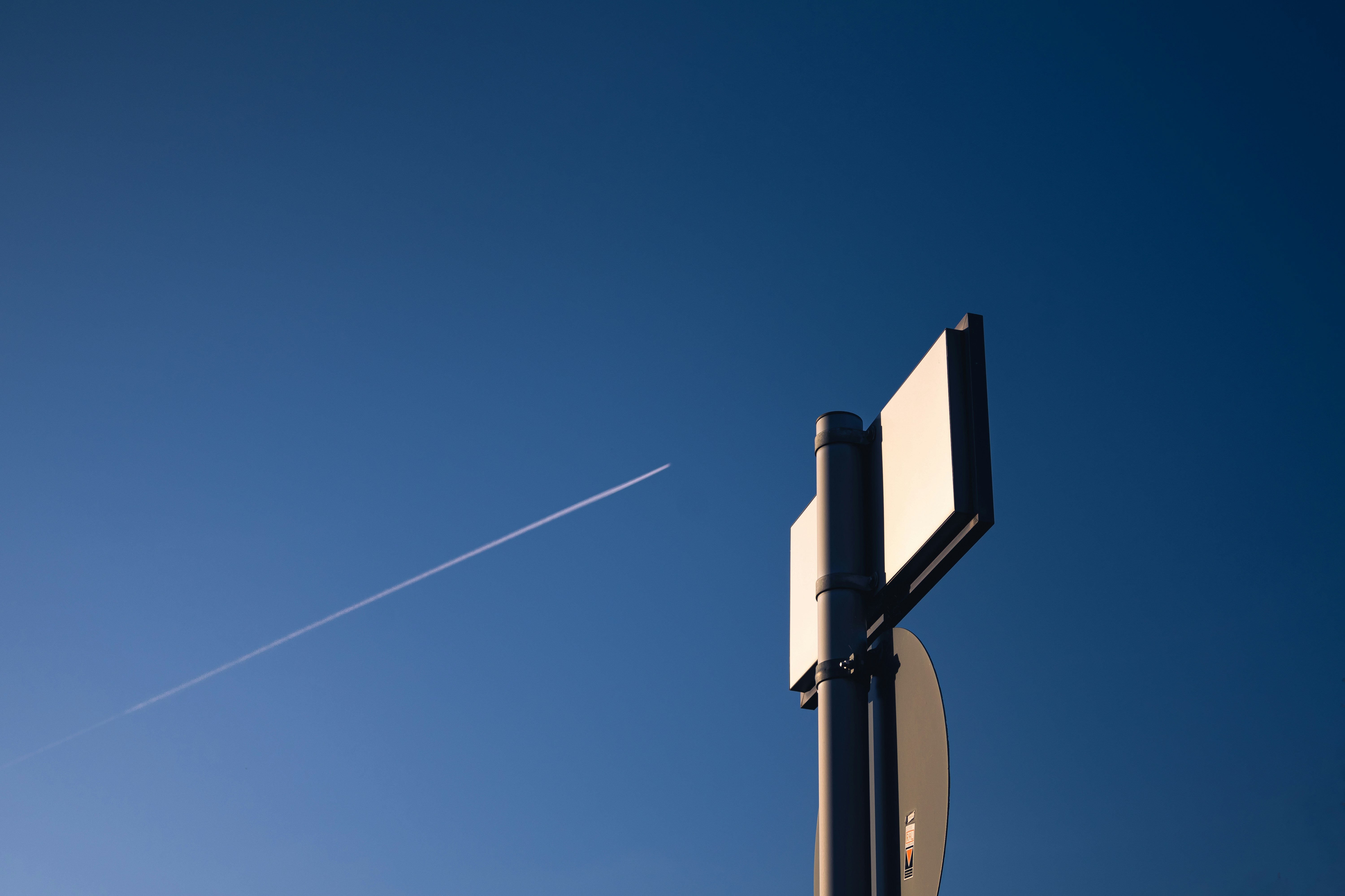Silhouette of a Signpost Against Clear Sky