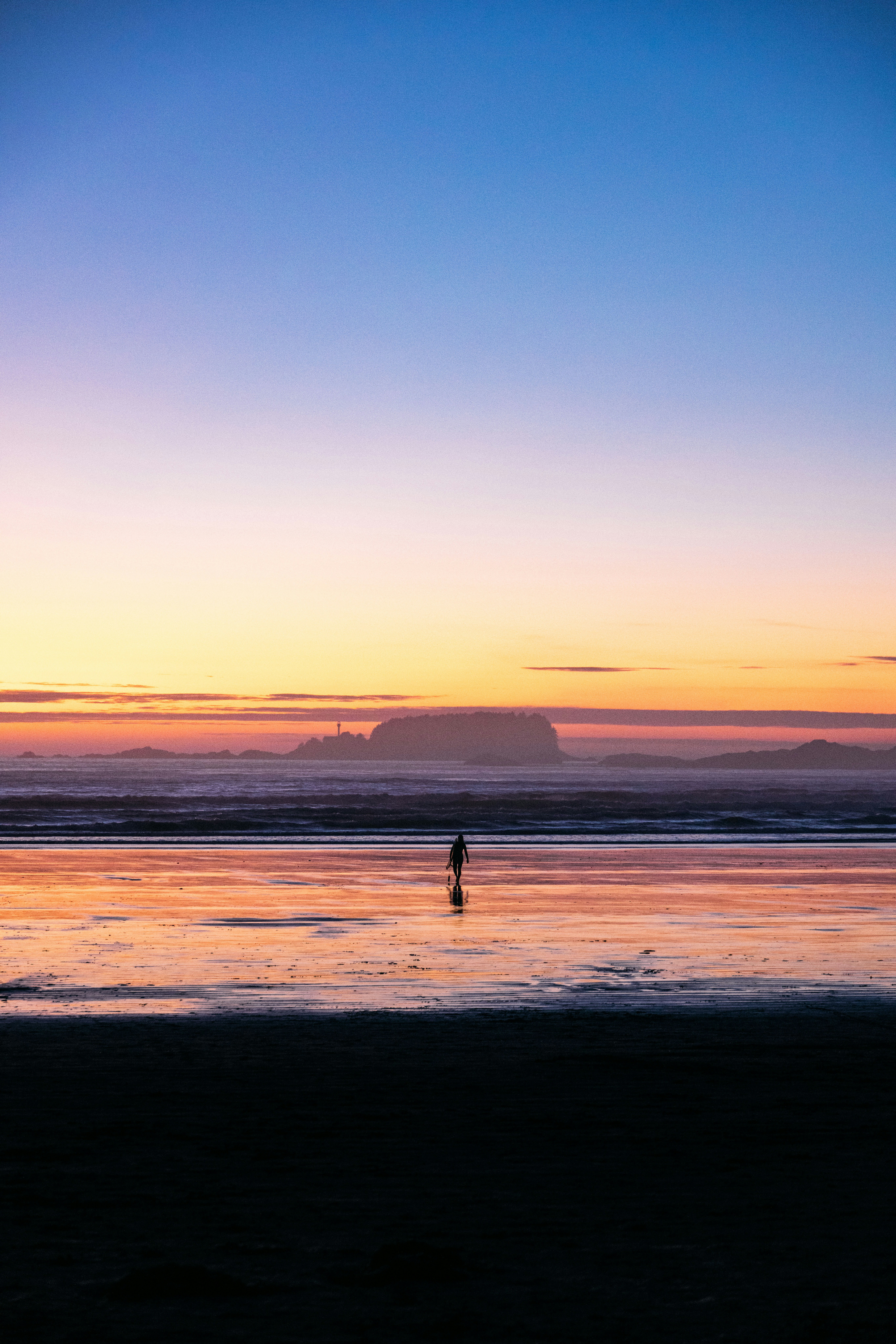 Silhouette on the Wet Stage: Dawn’s Quiet Tide