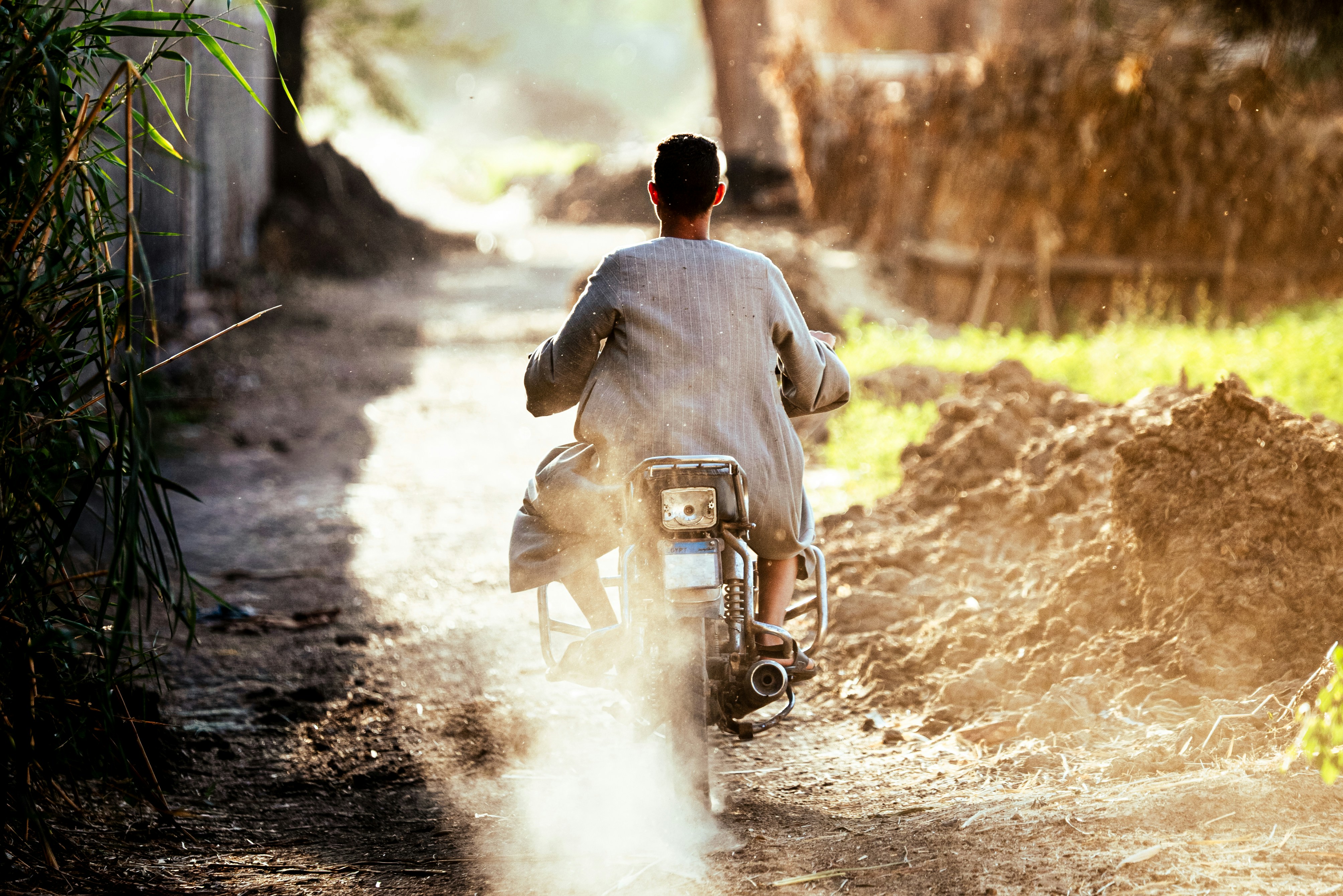  motorcycles of dust: rider carving through sunlit dirt