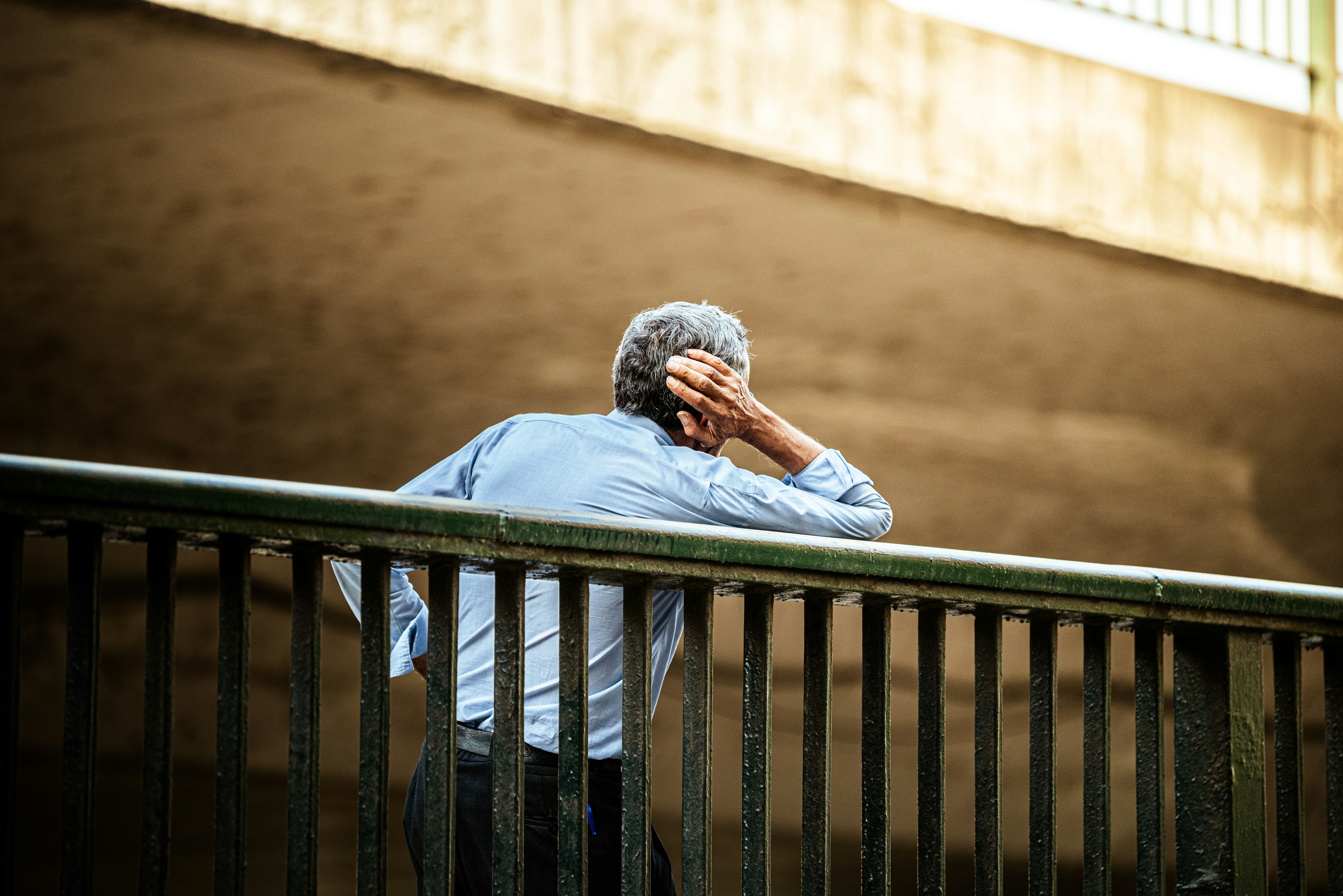 Over the Rail: A Quiet Pause on the City Bridge