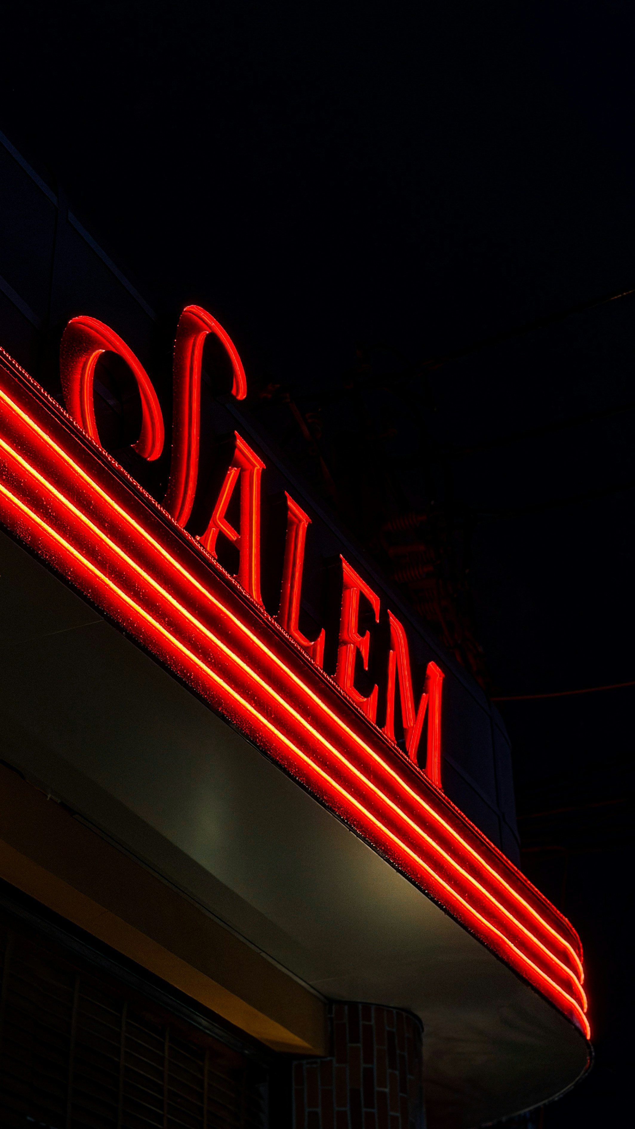 Neon Archive: Red Lettering along a Night Theater Facade