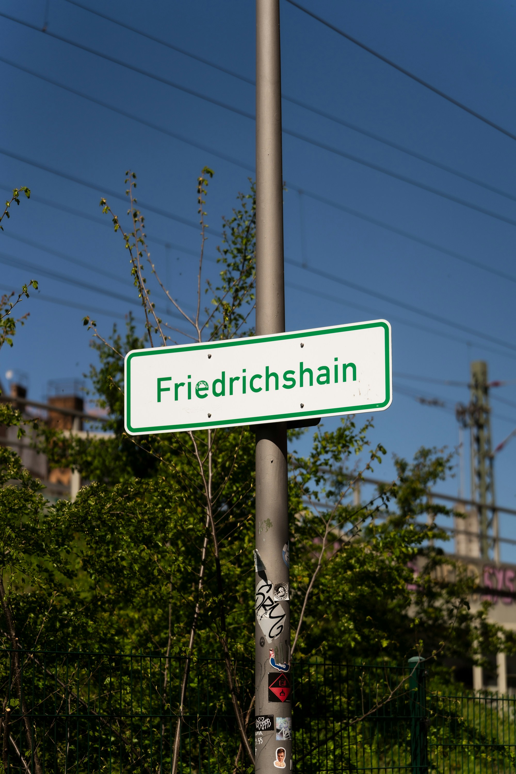 Green-framed Friedrichshain Street Sign Clings to a Metro Pole