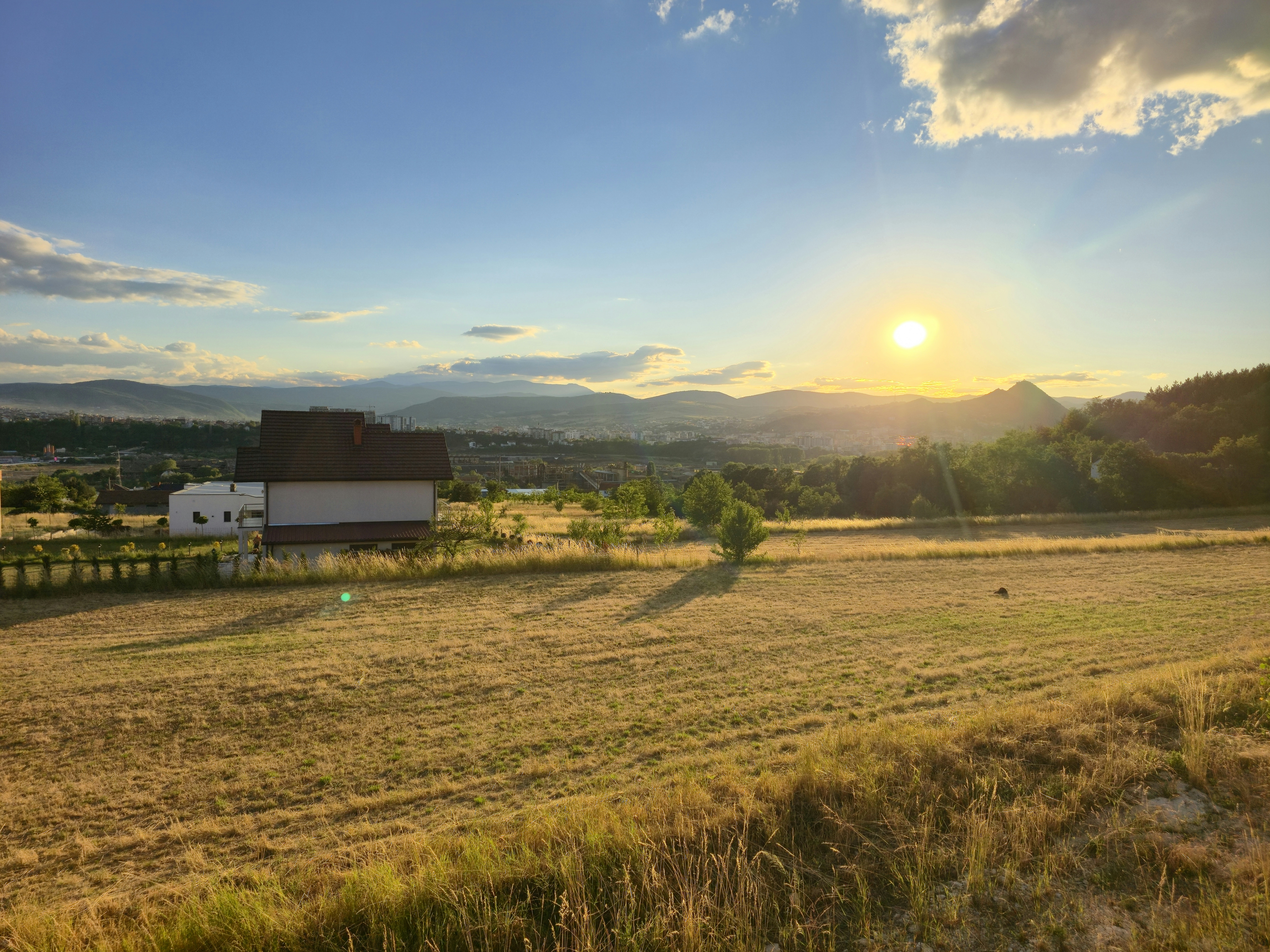 Golden Hour Farmstead Over the Rolling Field