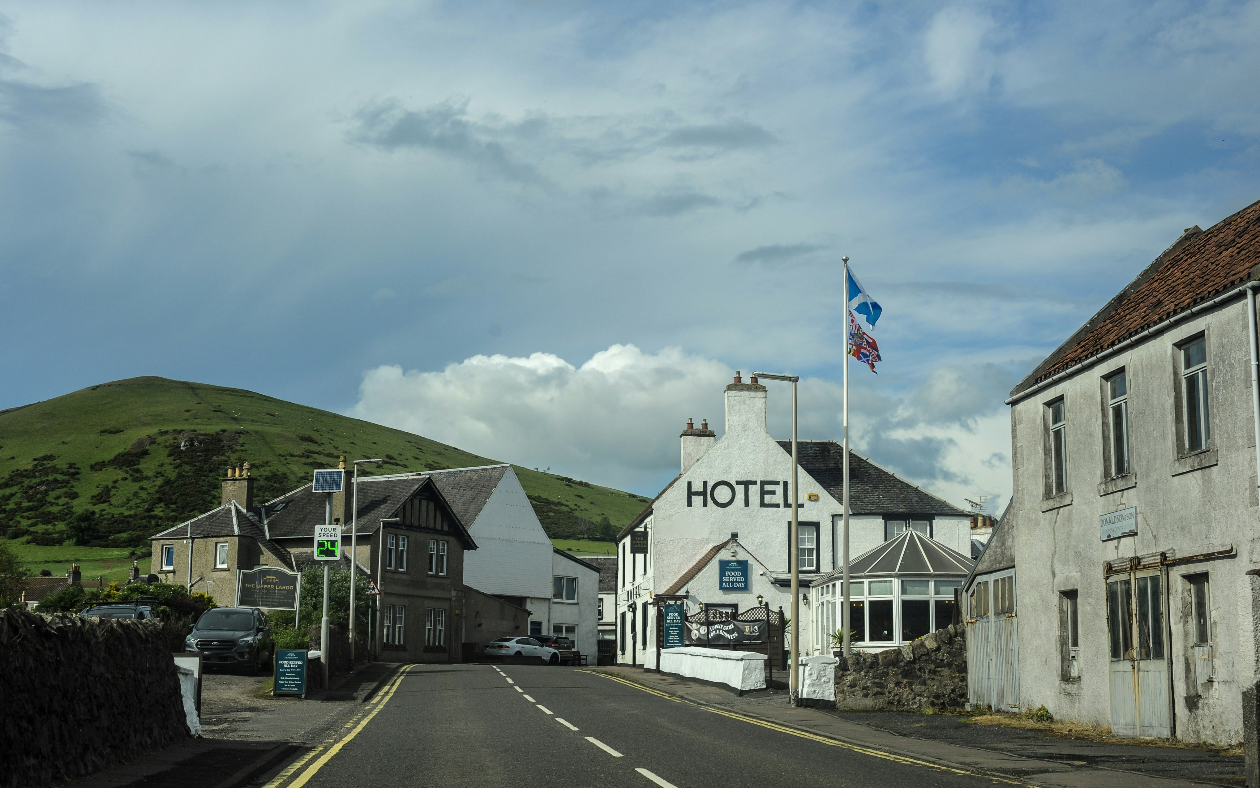 Sunlit Highland Street Toward the Hotel