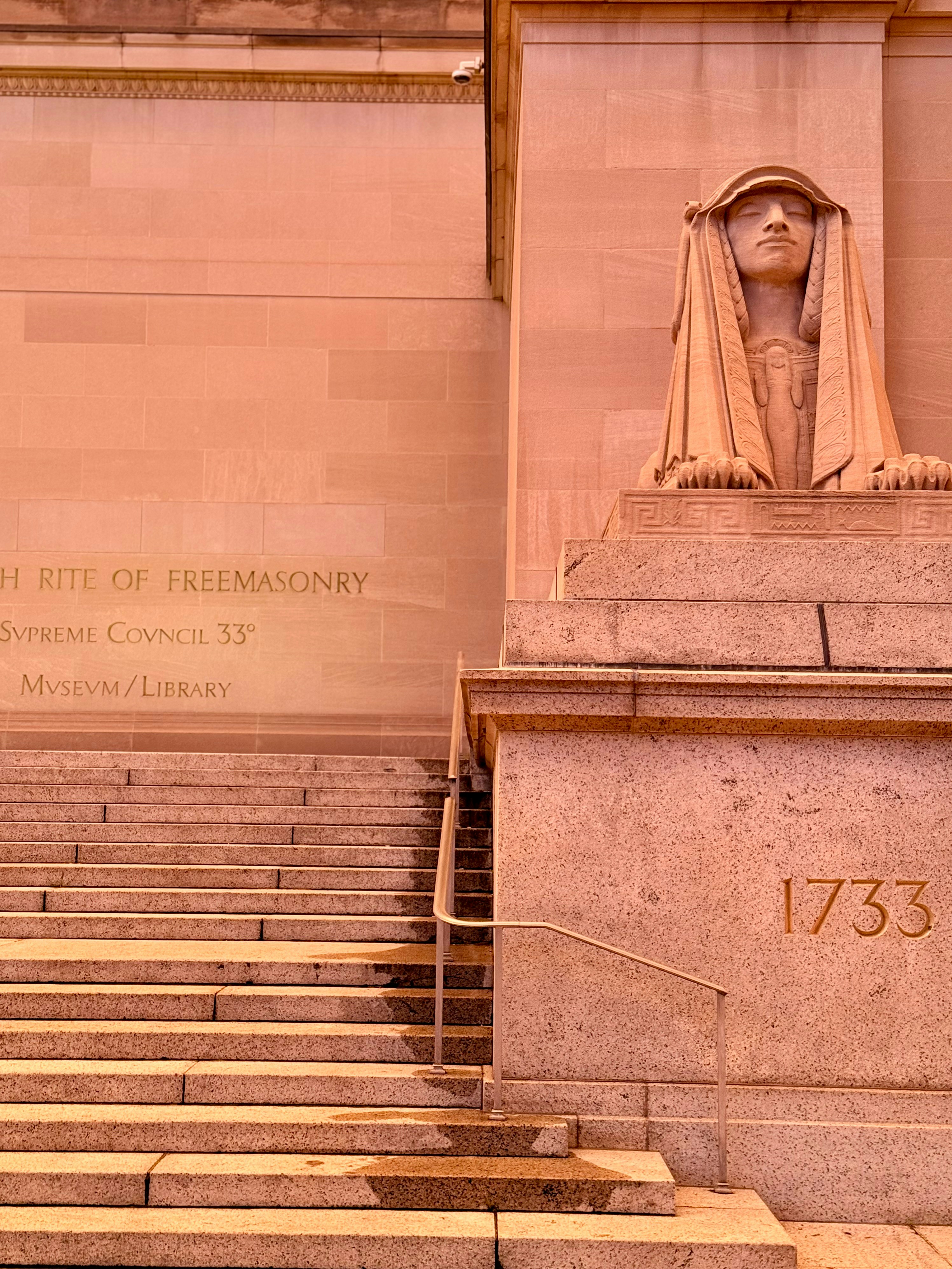 Stone Sentinel: The Framed Statue Above the Steps