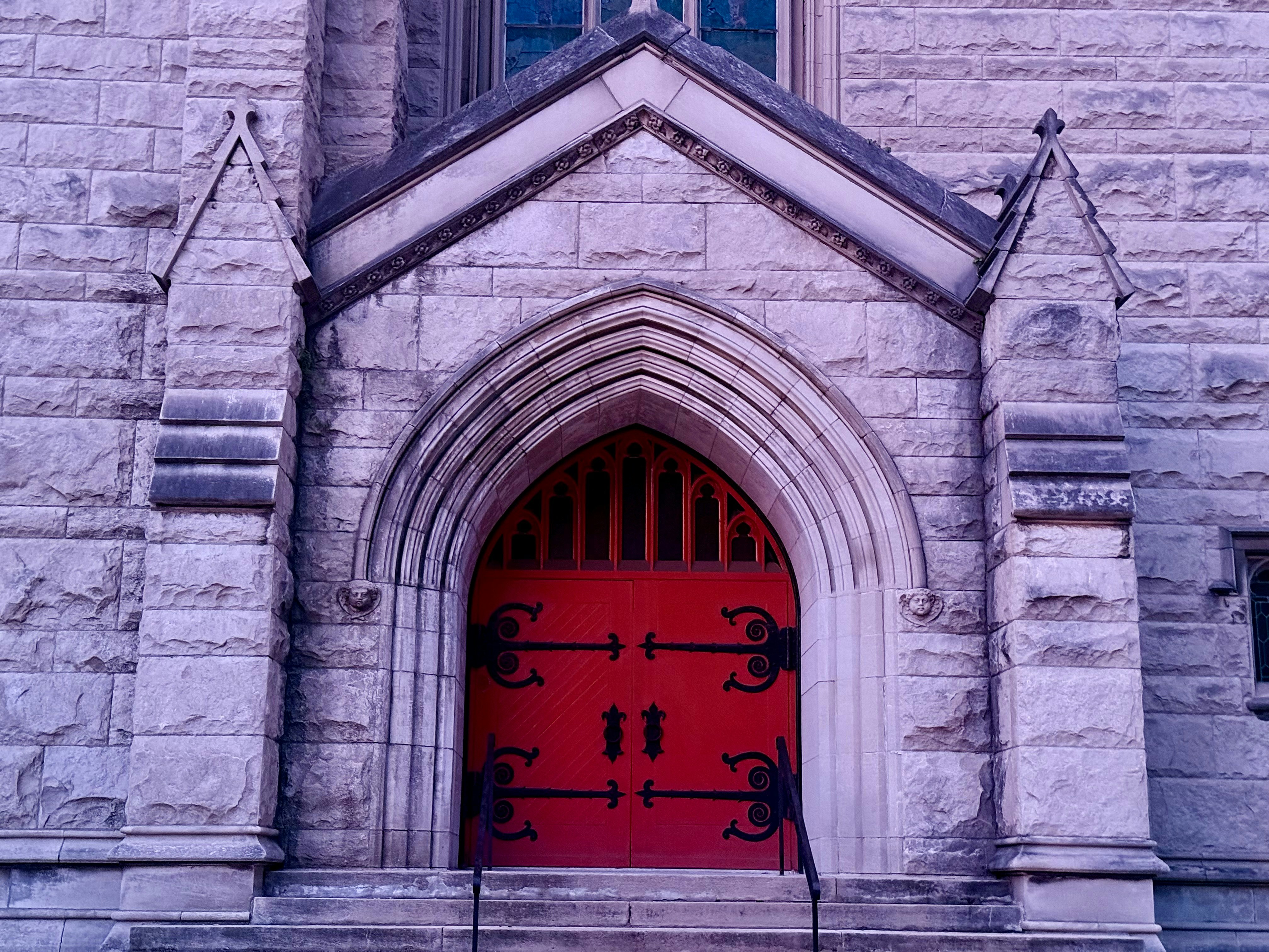 Red Door, Grey Stone: Votive Archway of a Quiet Church
