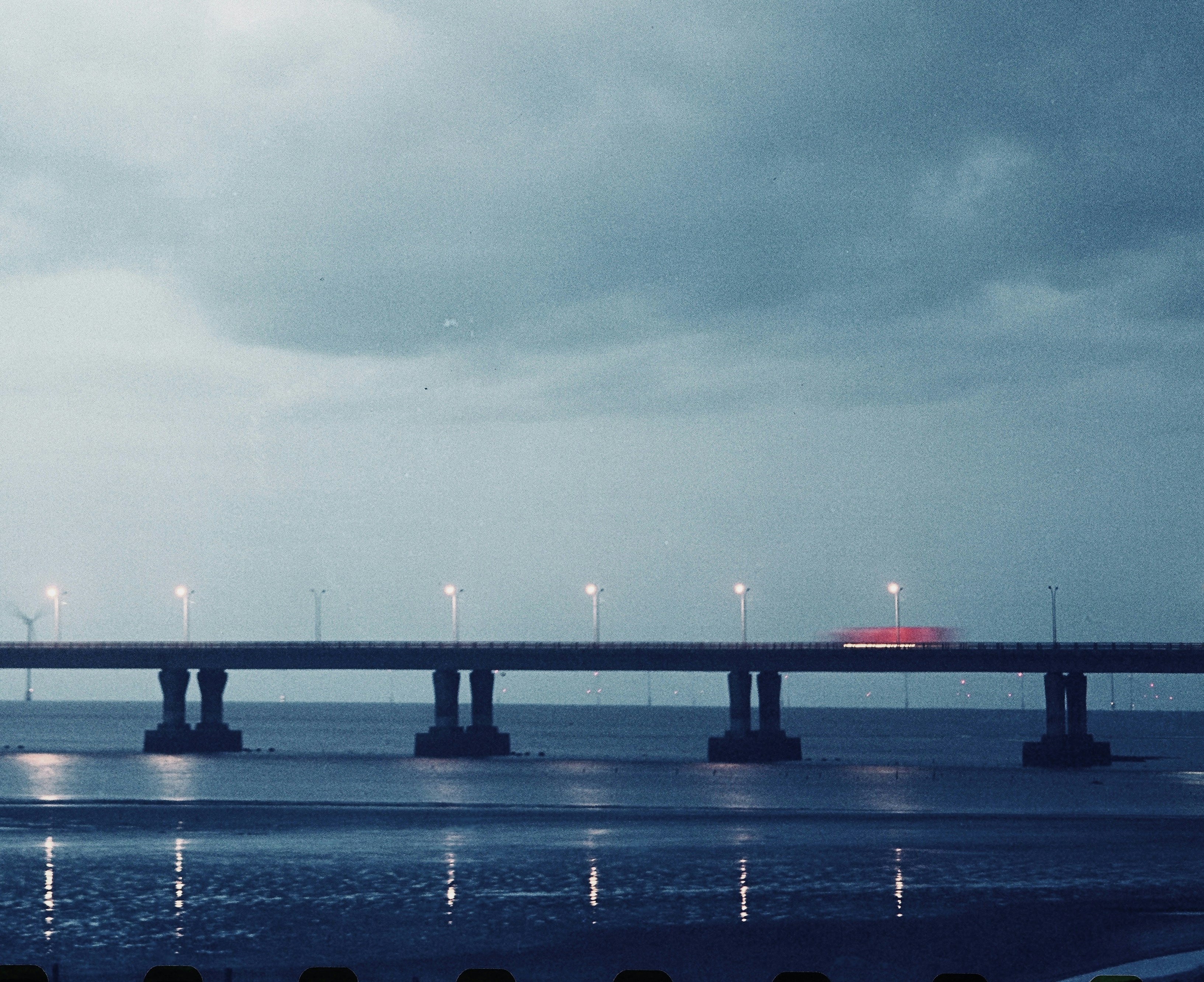 Evening Span: Lights Cling to the Quiet Bridge