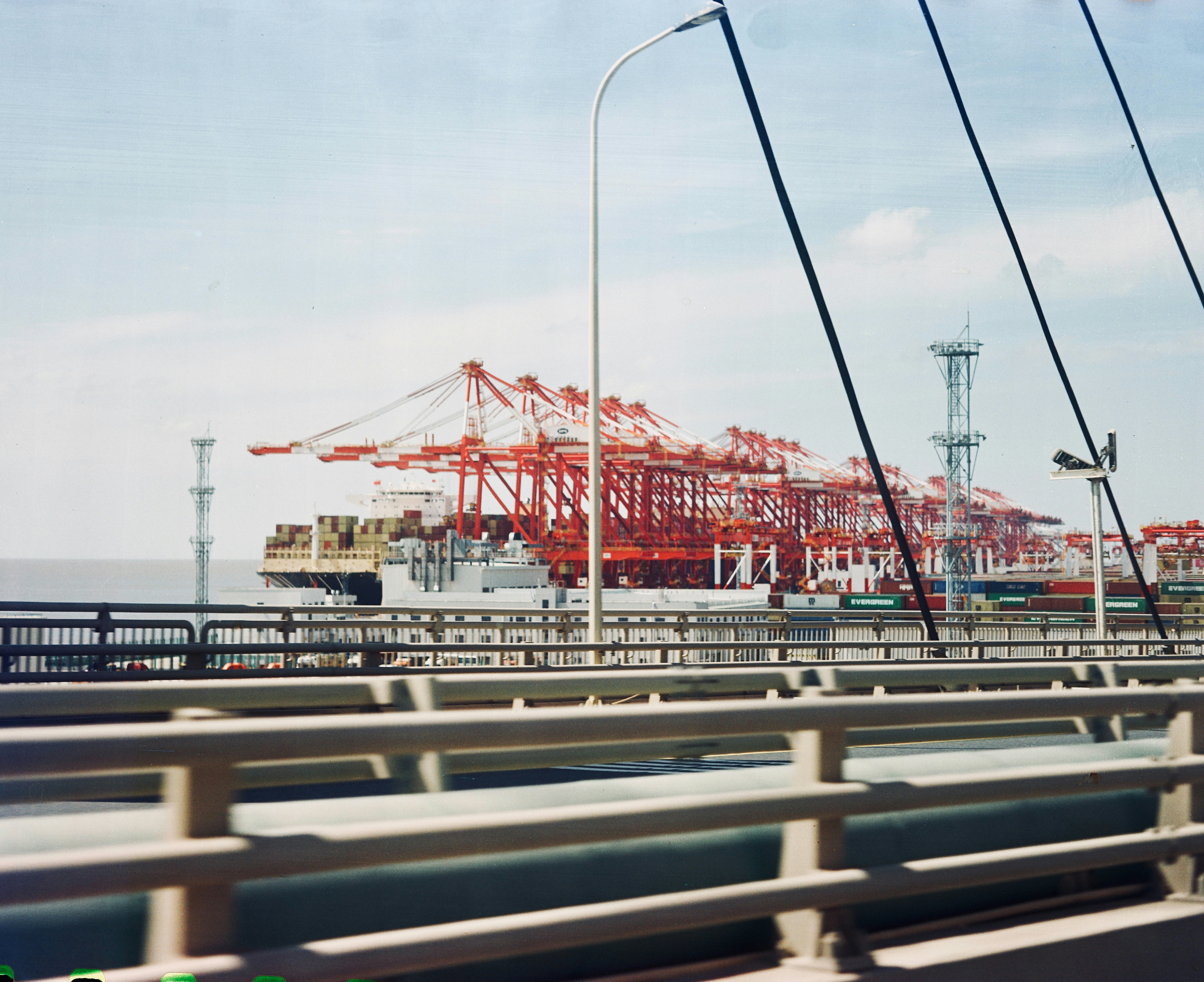 Harbor Giants: Red Cranes Rising Beyond the freeway