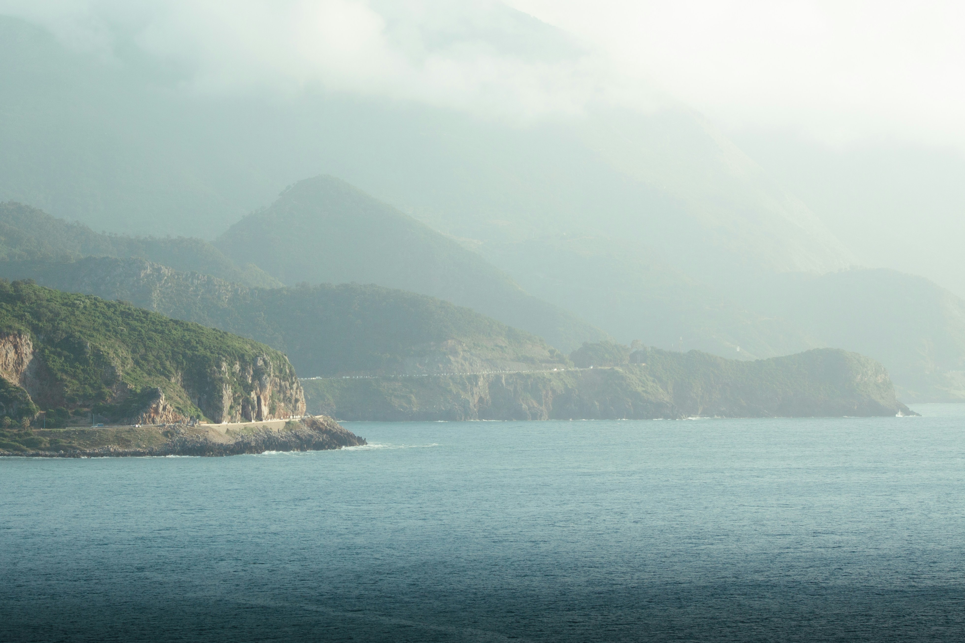 Mist-Softed Coastal Ridge Quietly Reaches the Sea