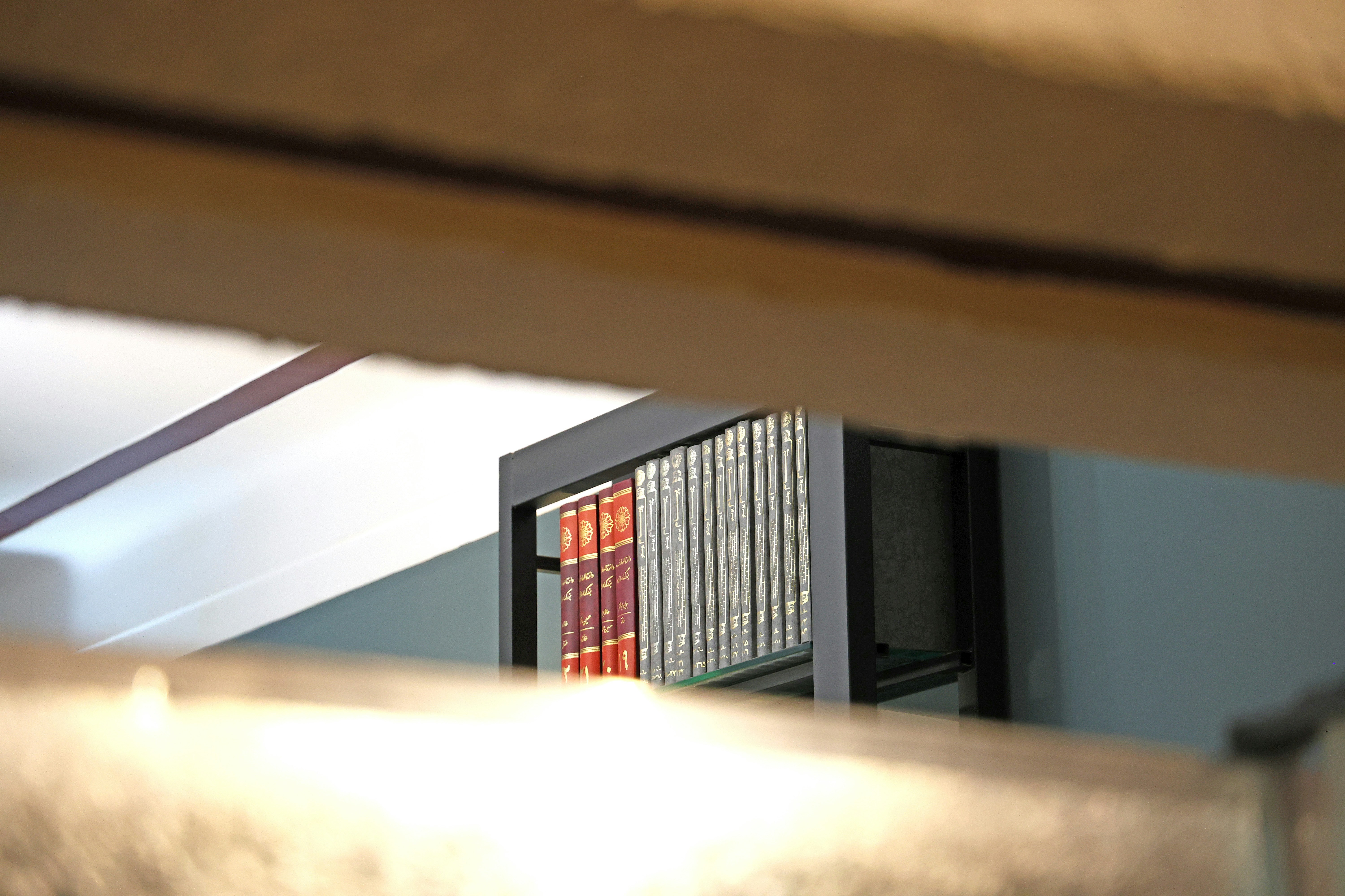 A narrow view reveals a shelf of books through a gap, suggesting a hidden library space rather than a conventional foreground scene.