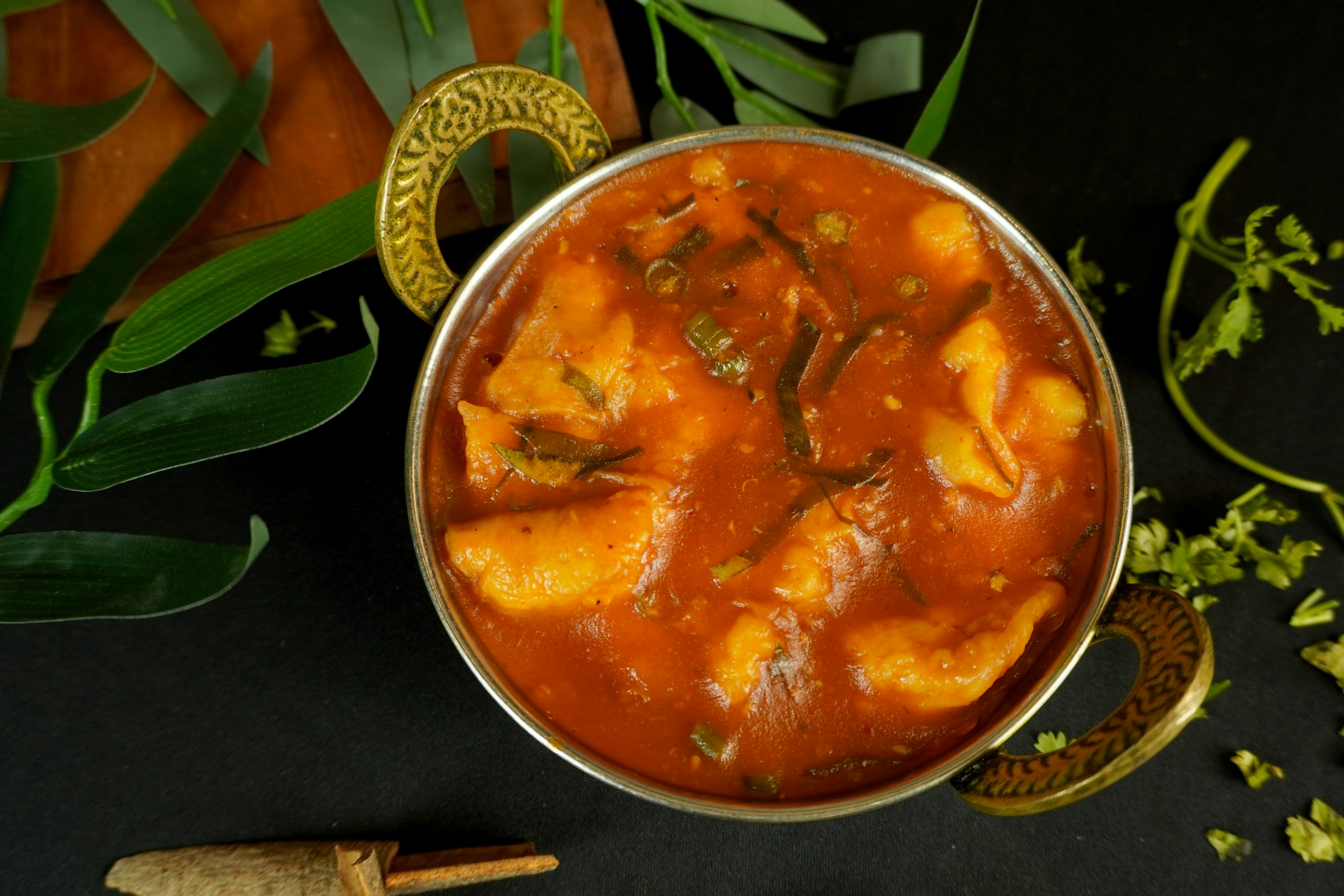 Savory Kerala-style Fish Curry in a Shiny Brimmed Pot