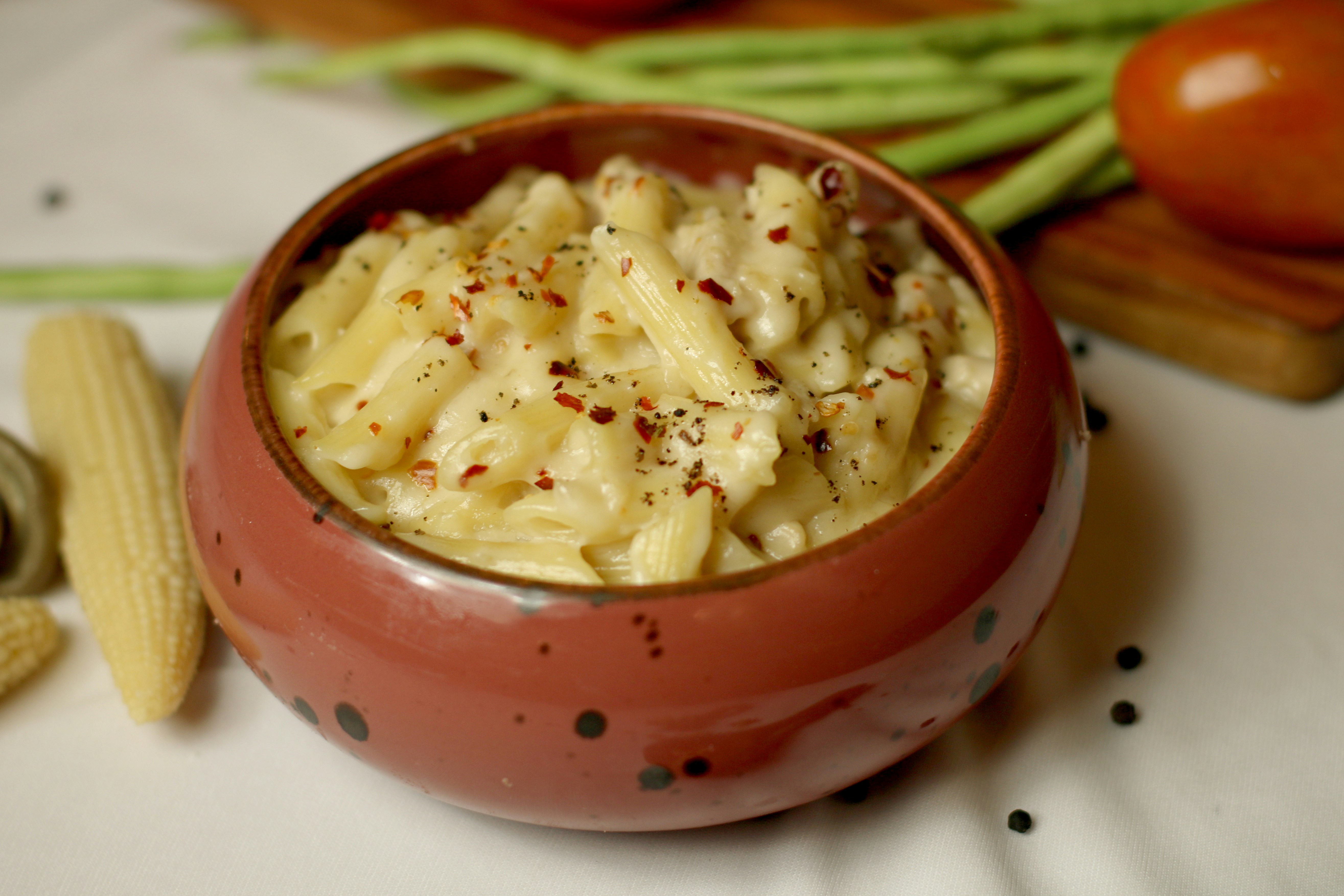 Creamy penne in a rustic clay bowl with a peppery finish