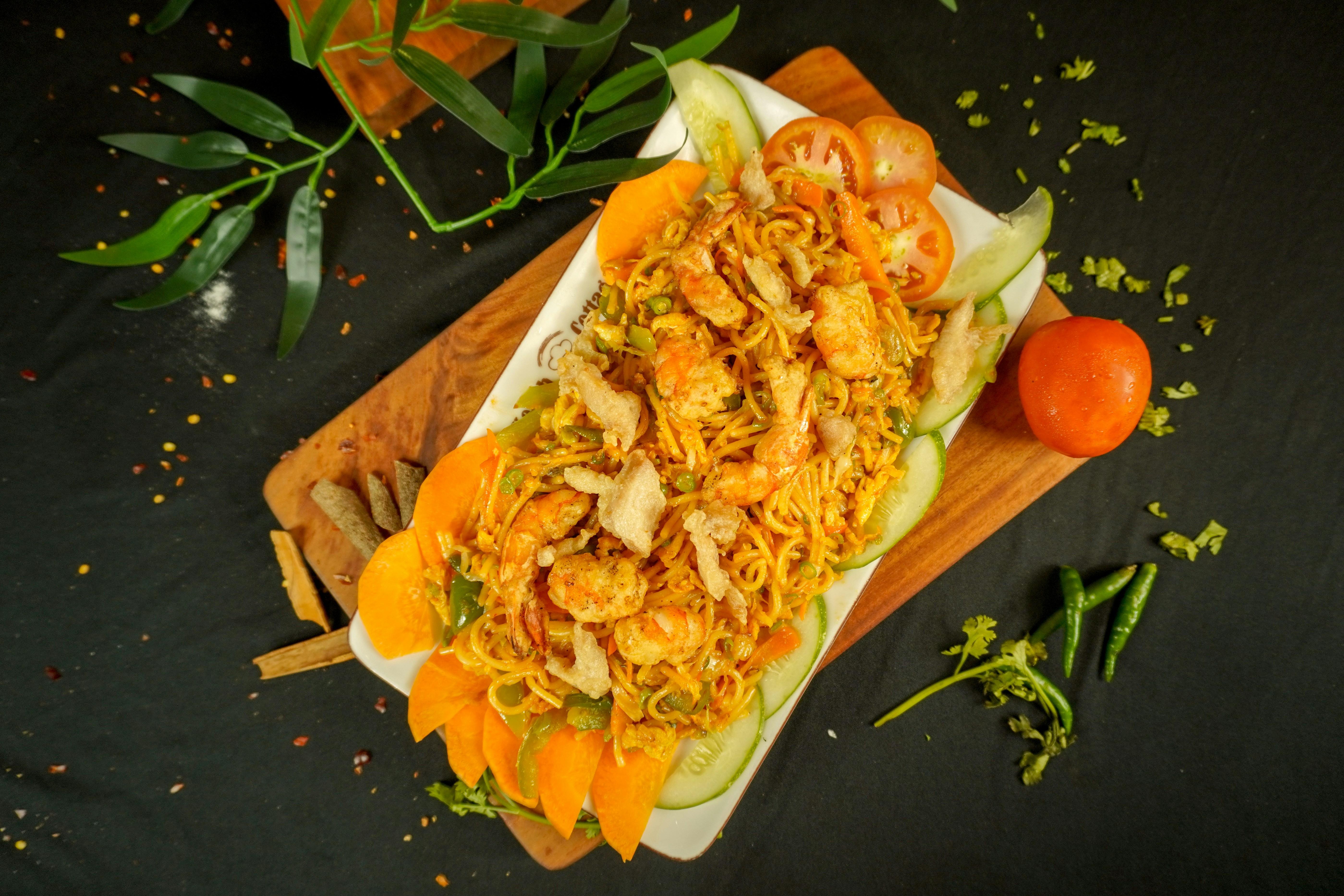 Crispy fried seafood platter on a rectangular white dish with citrus and greens