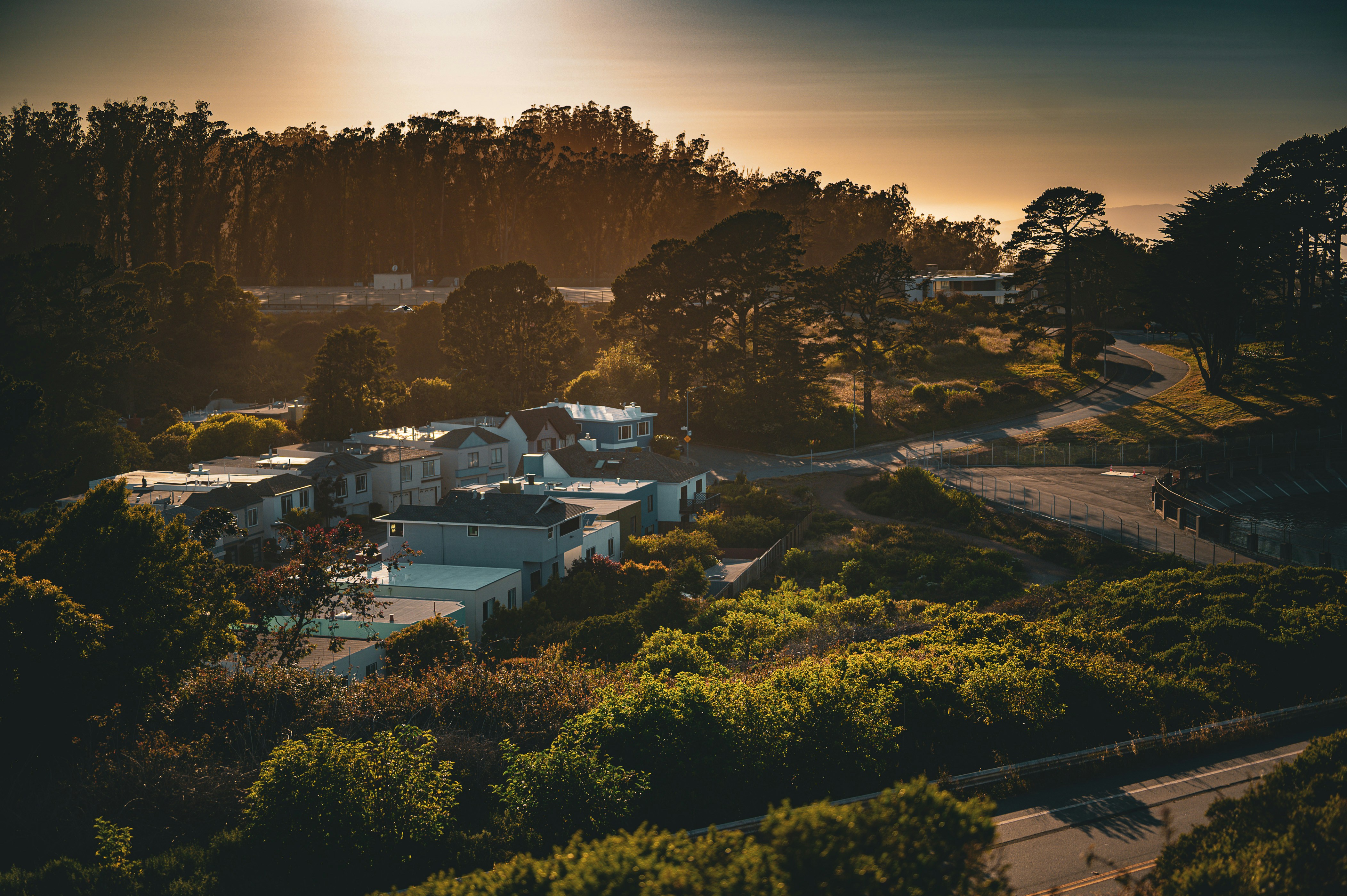 Sunlit Coastal Village Emerges from Evening Haze
