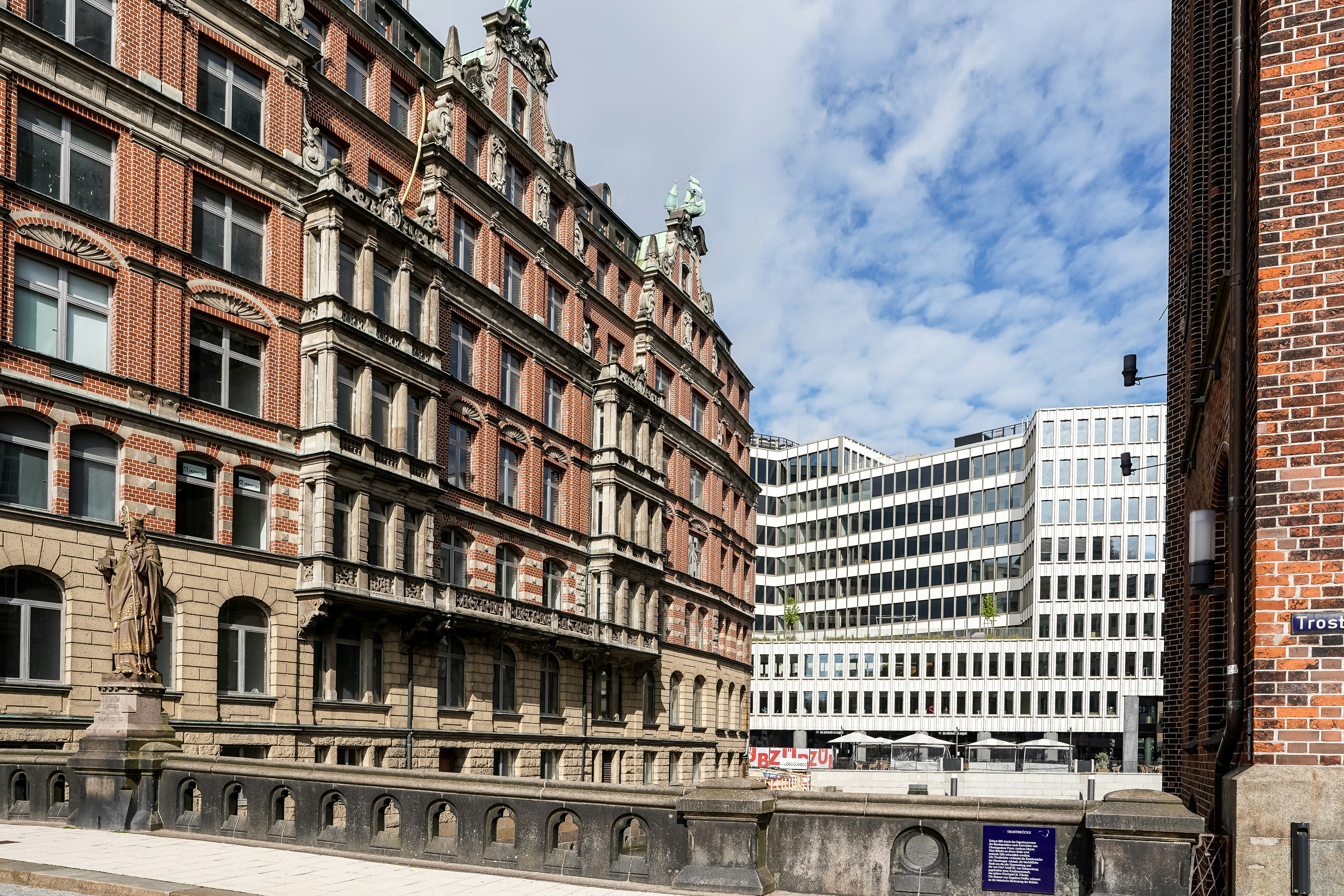 Brick-and-Glass Crossroad: A City Block Meeting under a Bright Sky