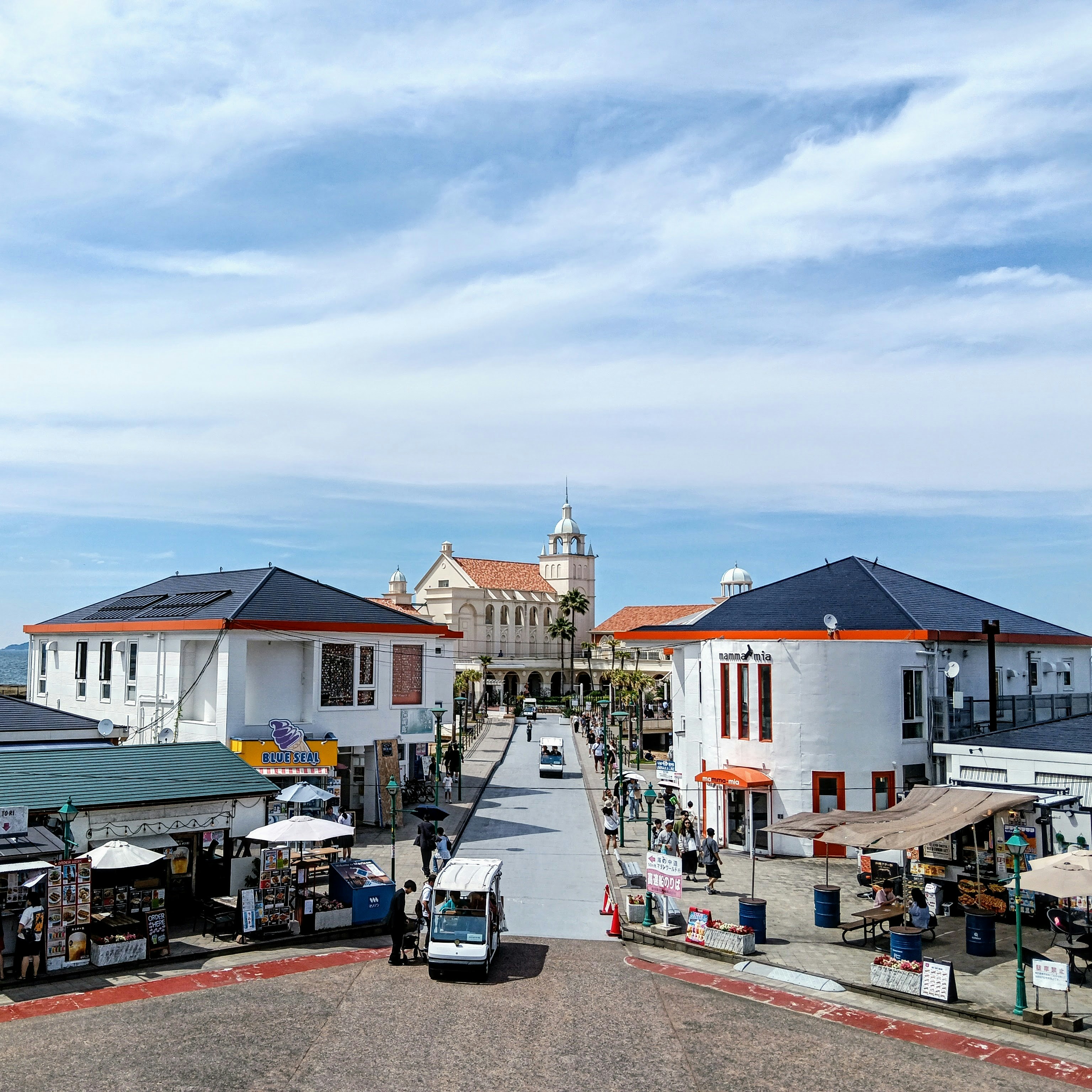Sunlit Calle Principal: A Coastal Town's Central Avenue